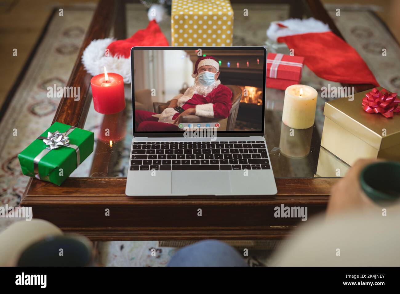 Santa claus wearing face mask on laptop video call screen at christmas ...