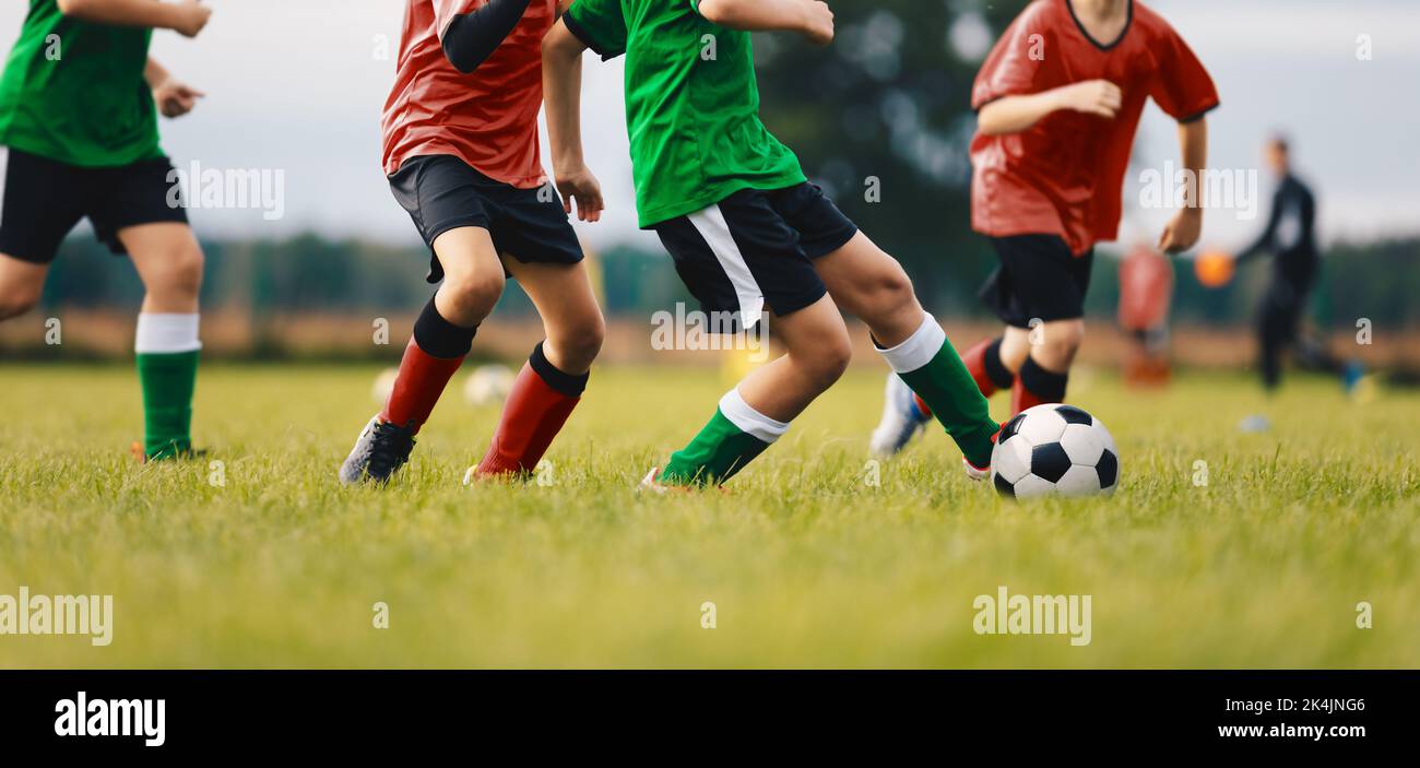 Children play football game. Kids in two teams kicking soccer classic ...