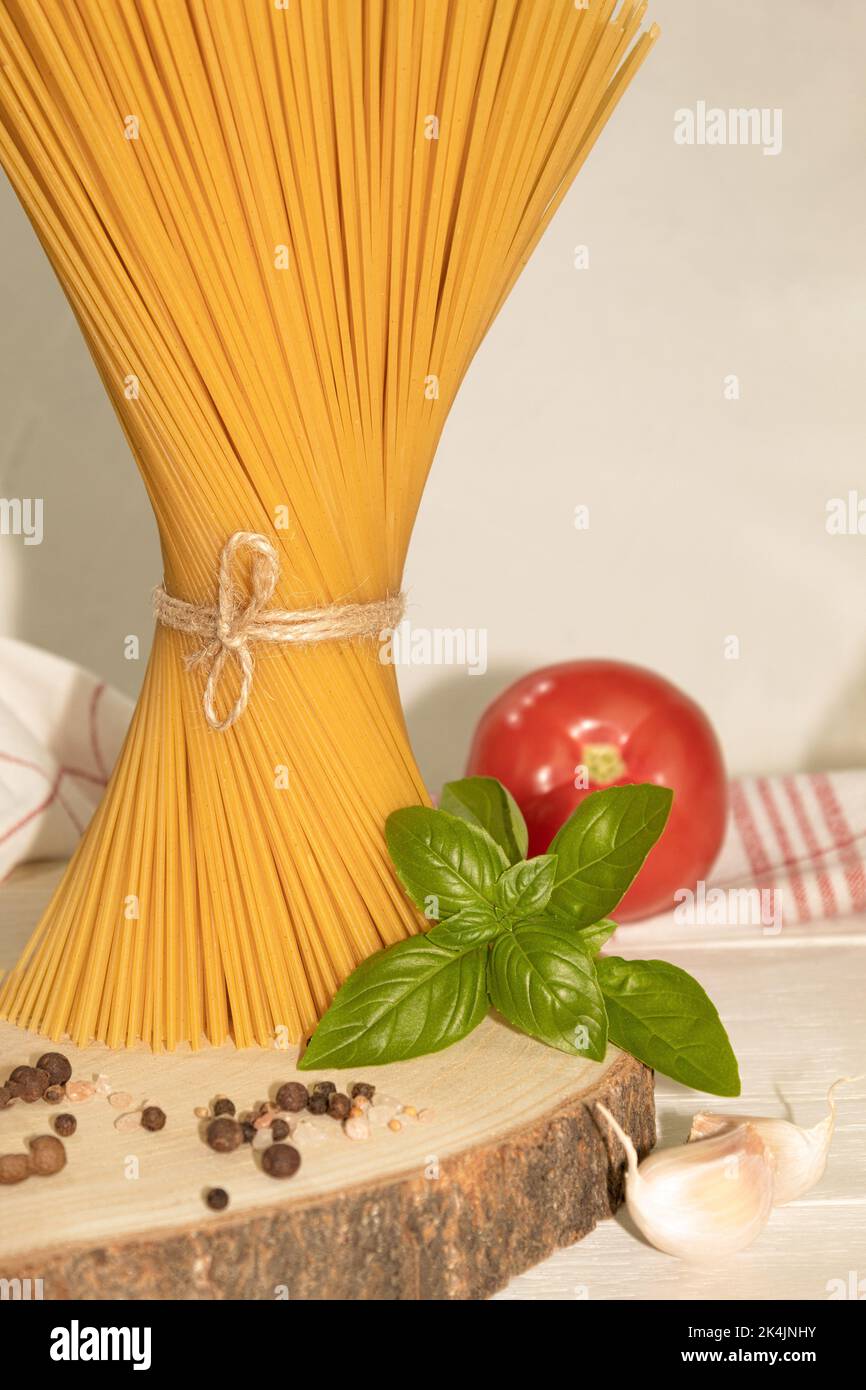 On the table is a pack of spaghetti tied with string. On a light ...