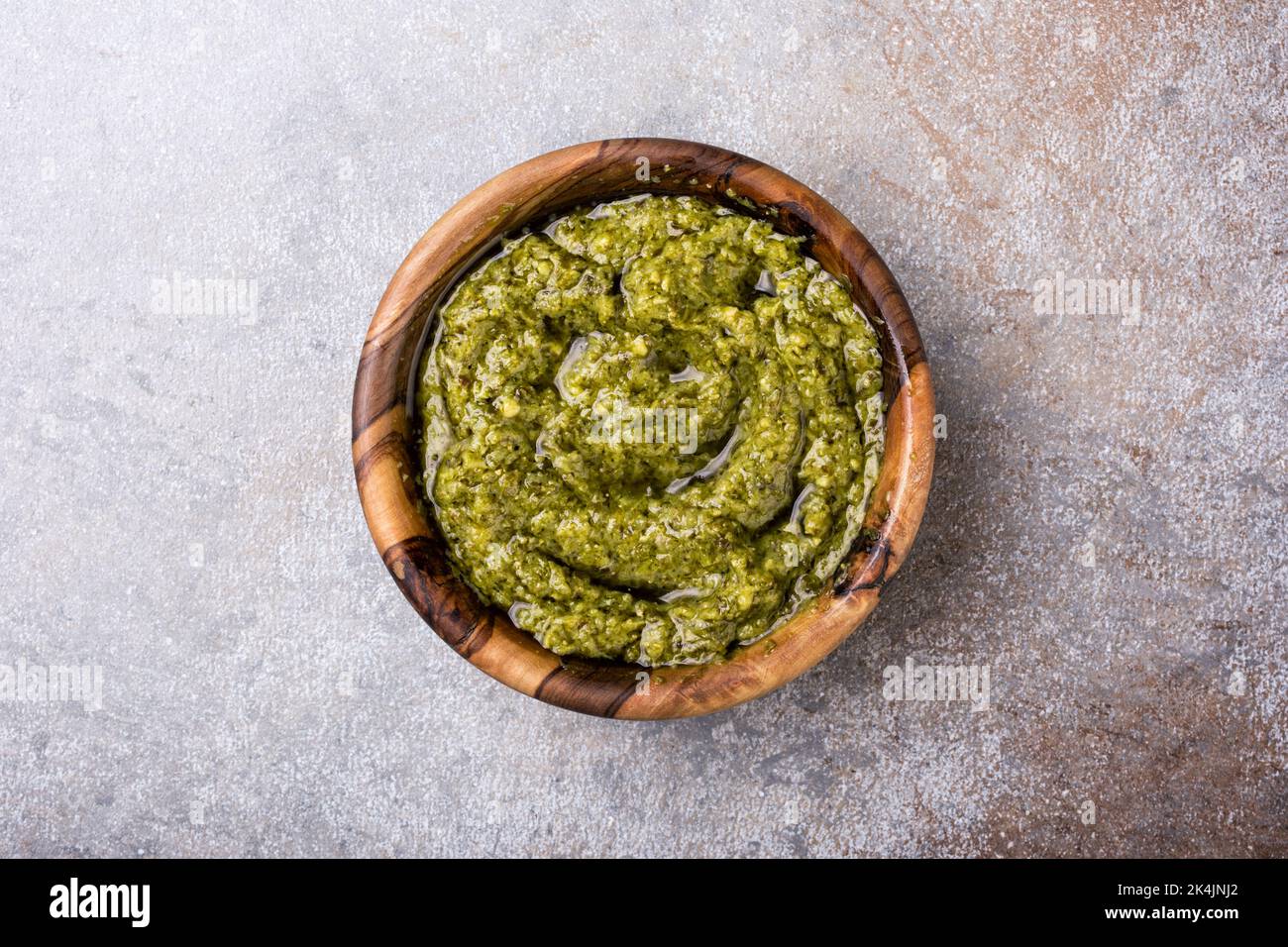 Top view of pesto sauce in wooden bowl as ingredient for tasty pasta ...
