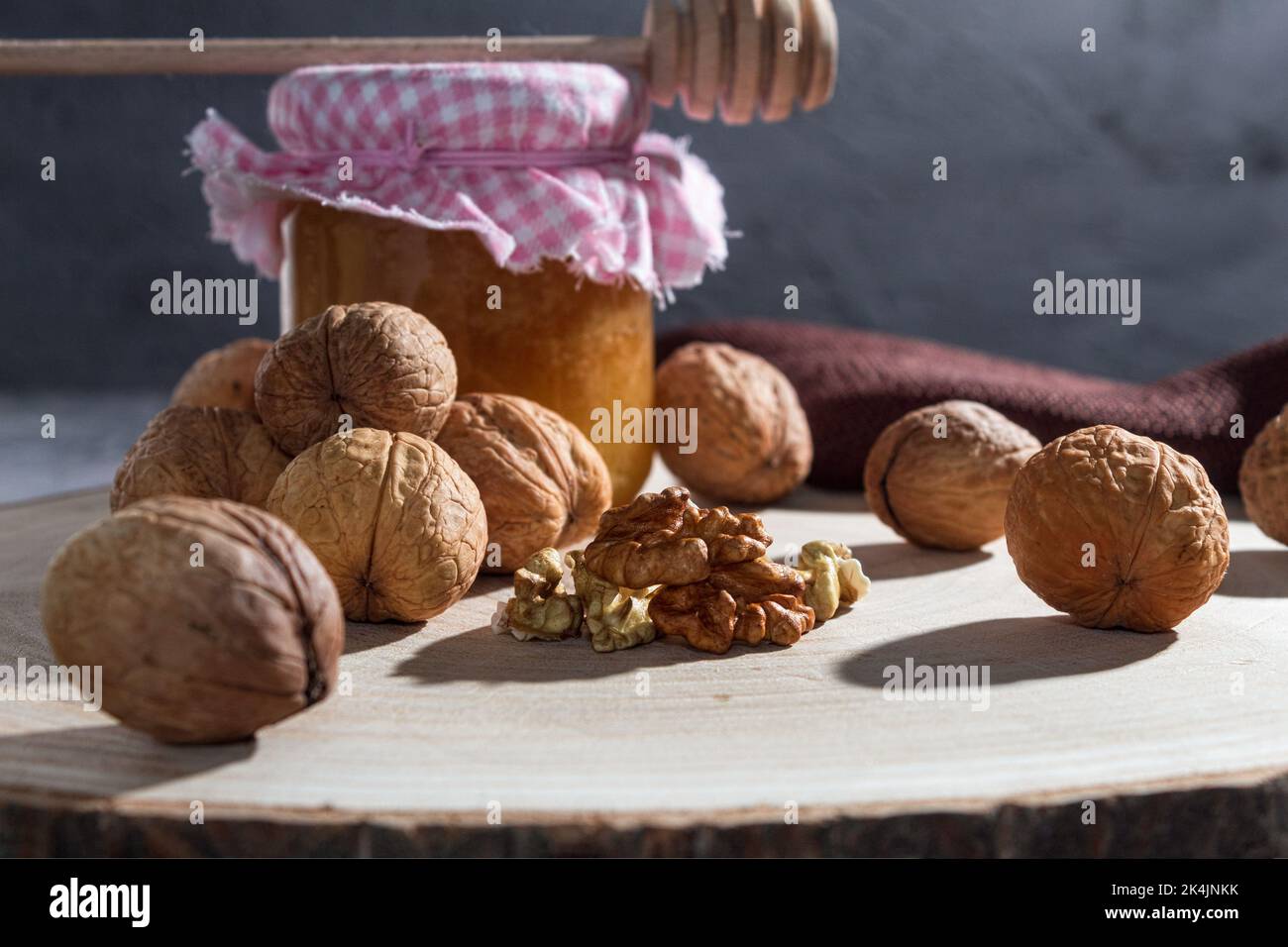 Nuts and a jar of honey, close-up. Cheese and honey with nuts on the ...