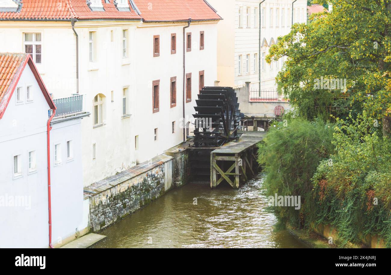 Water wooden wheel for an antique door. Urban landscape. Old mill and ...