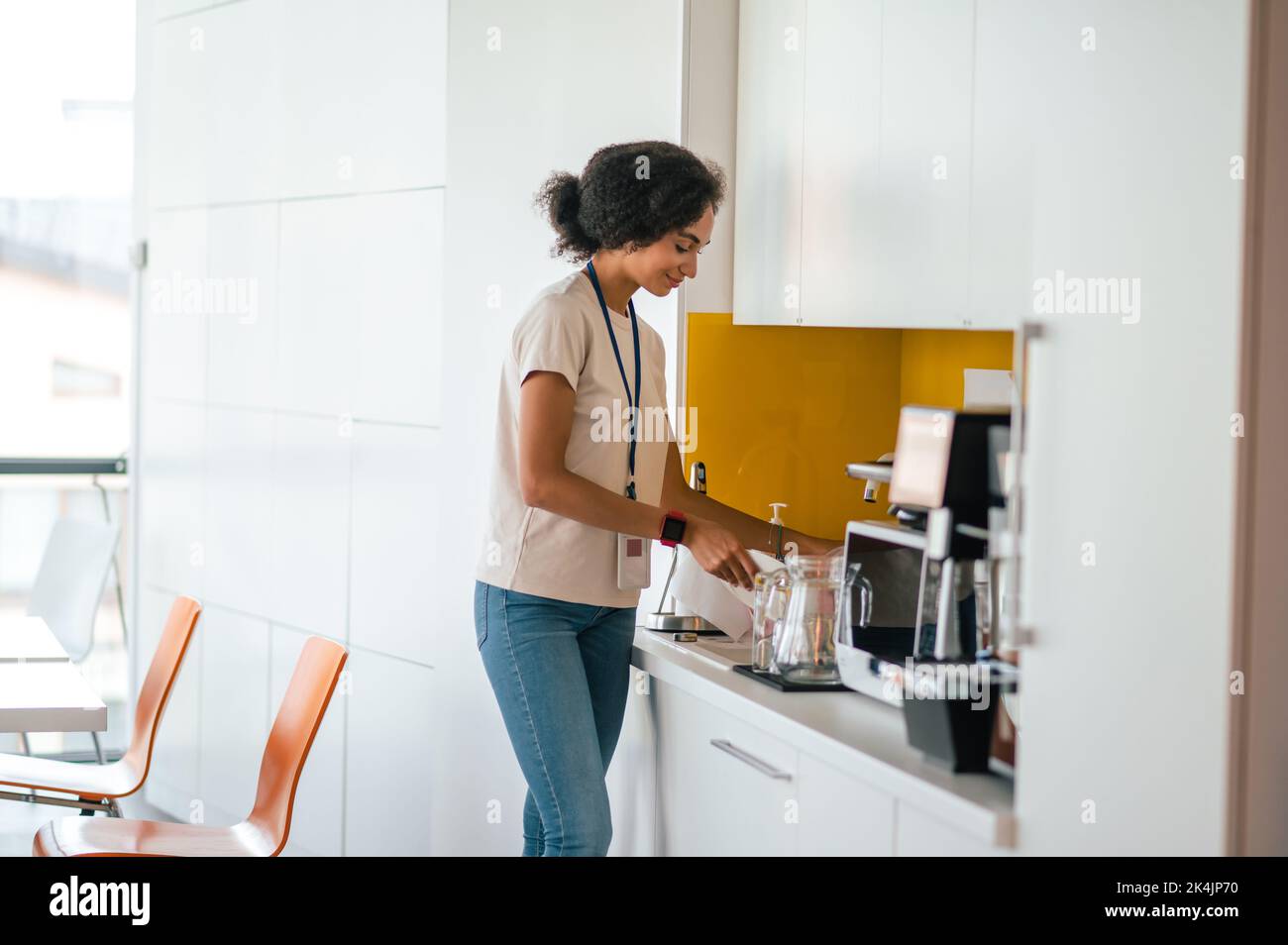 Female office worker in the office swithing on a microwave oven Stock ...