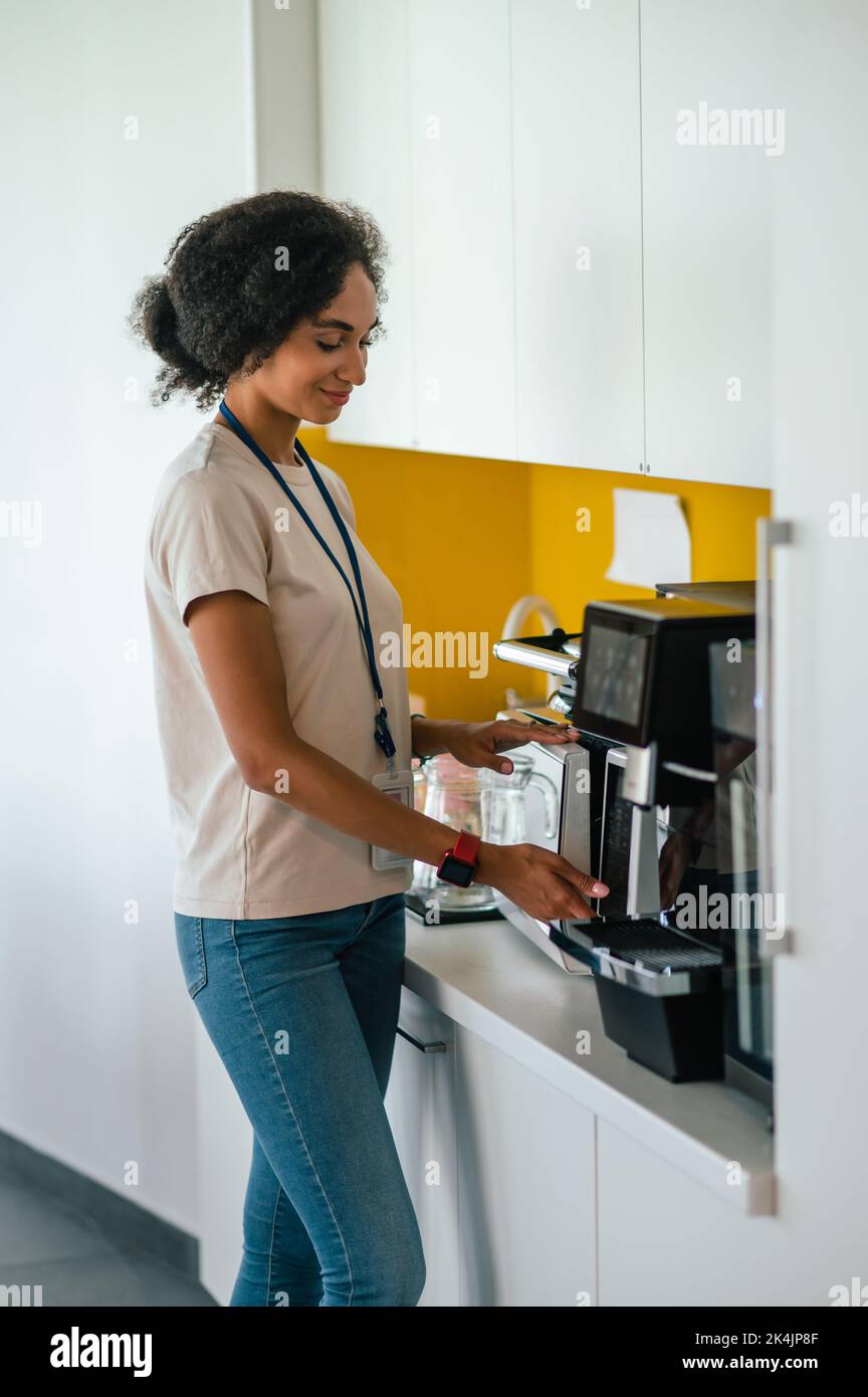 Female office worker in the office swithing on a microwave oven Stock ...