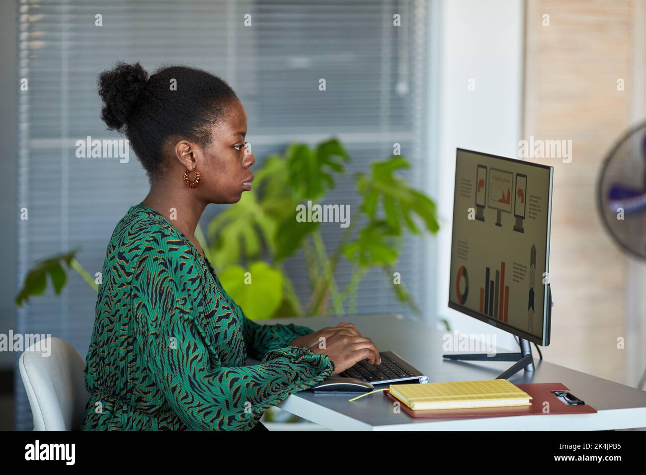 Young analyst or creative designer looking through graphic information ...