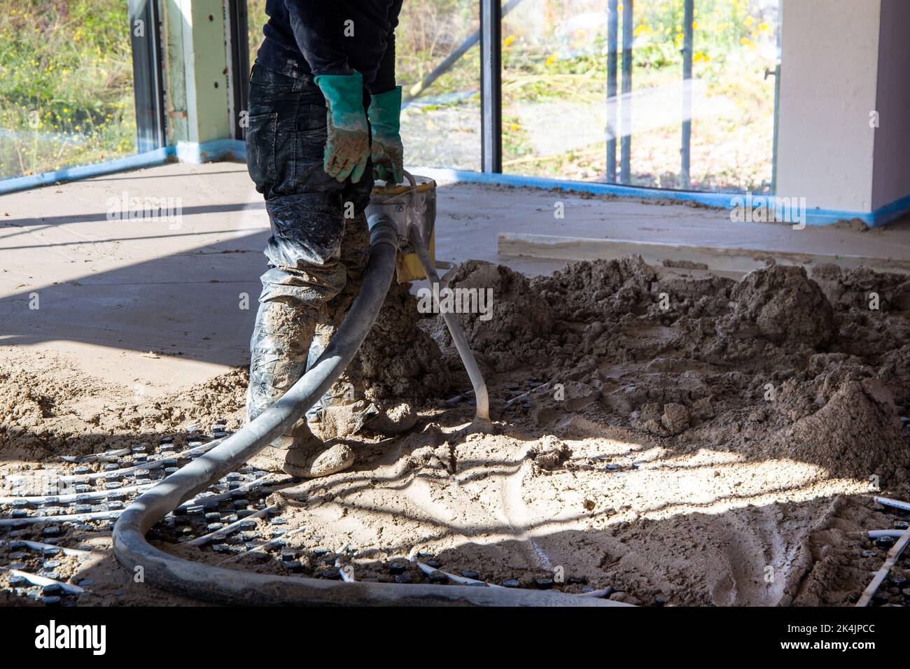 Delivery of flowing screed indoors Stock Photo - Alamy