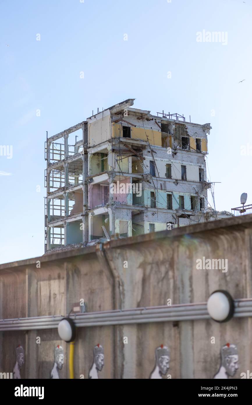 A vertical shot of a half-ruined residential high-rise building with ...