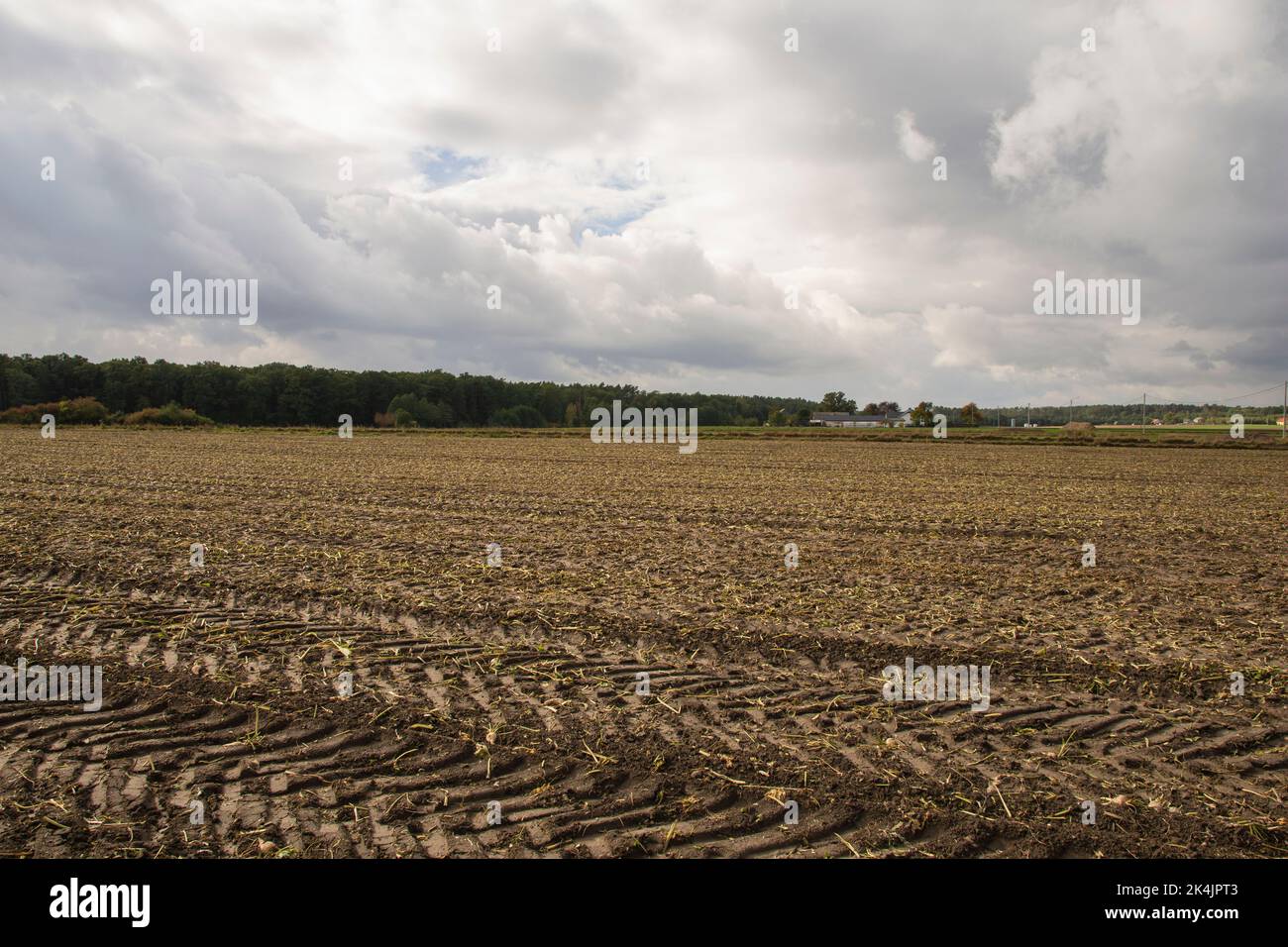 Dark clouds over the plowed field and the village in the background ...