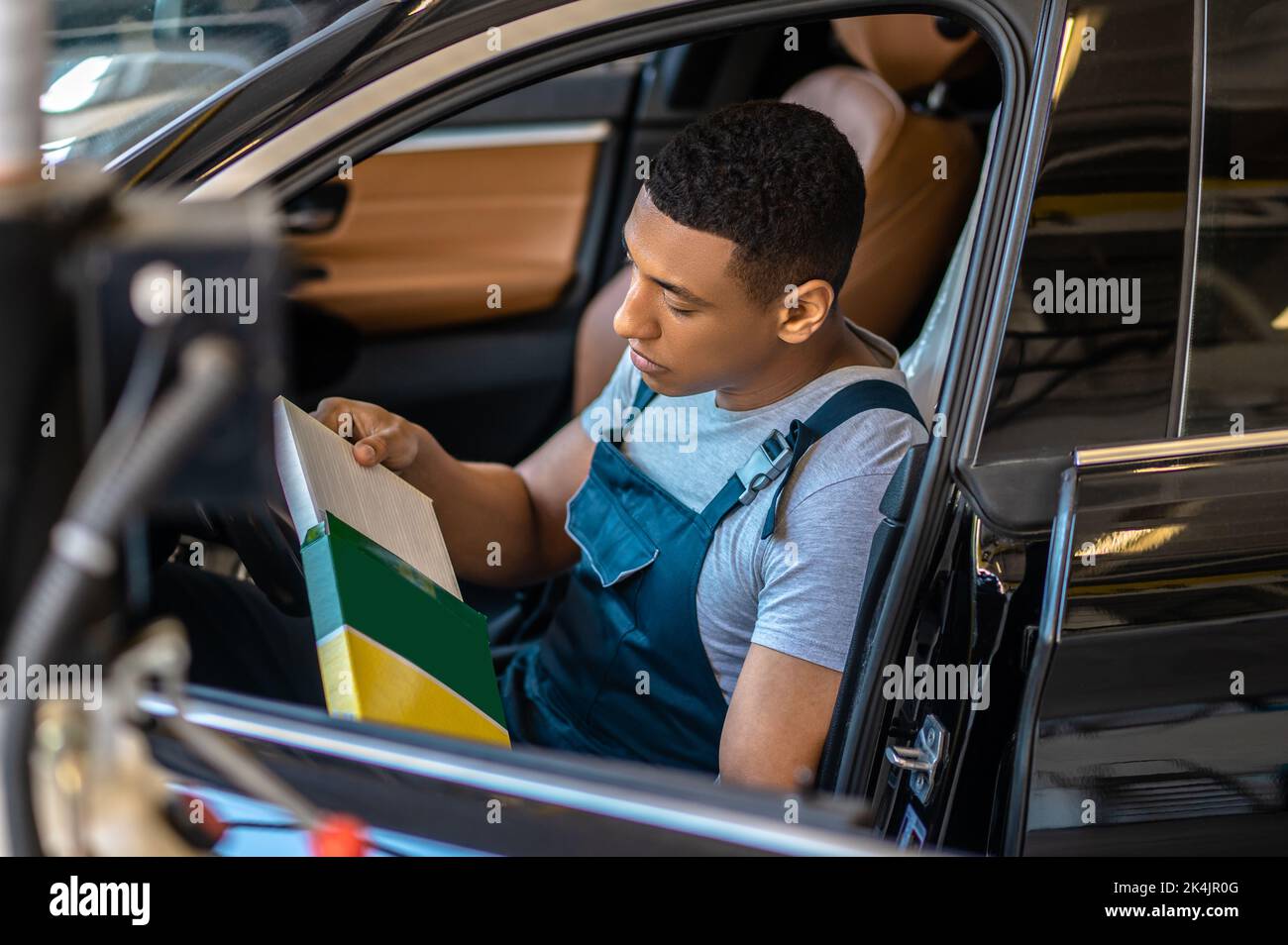 Professional African American mechanic fixing the customer car Stock ...