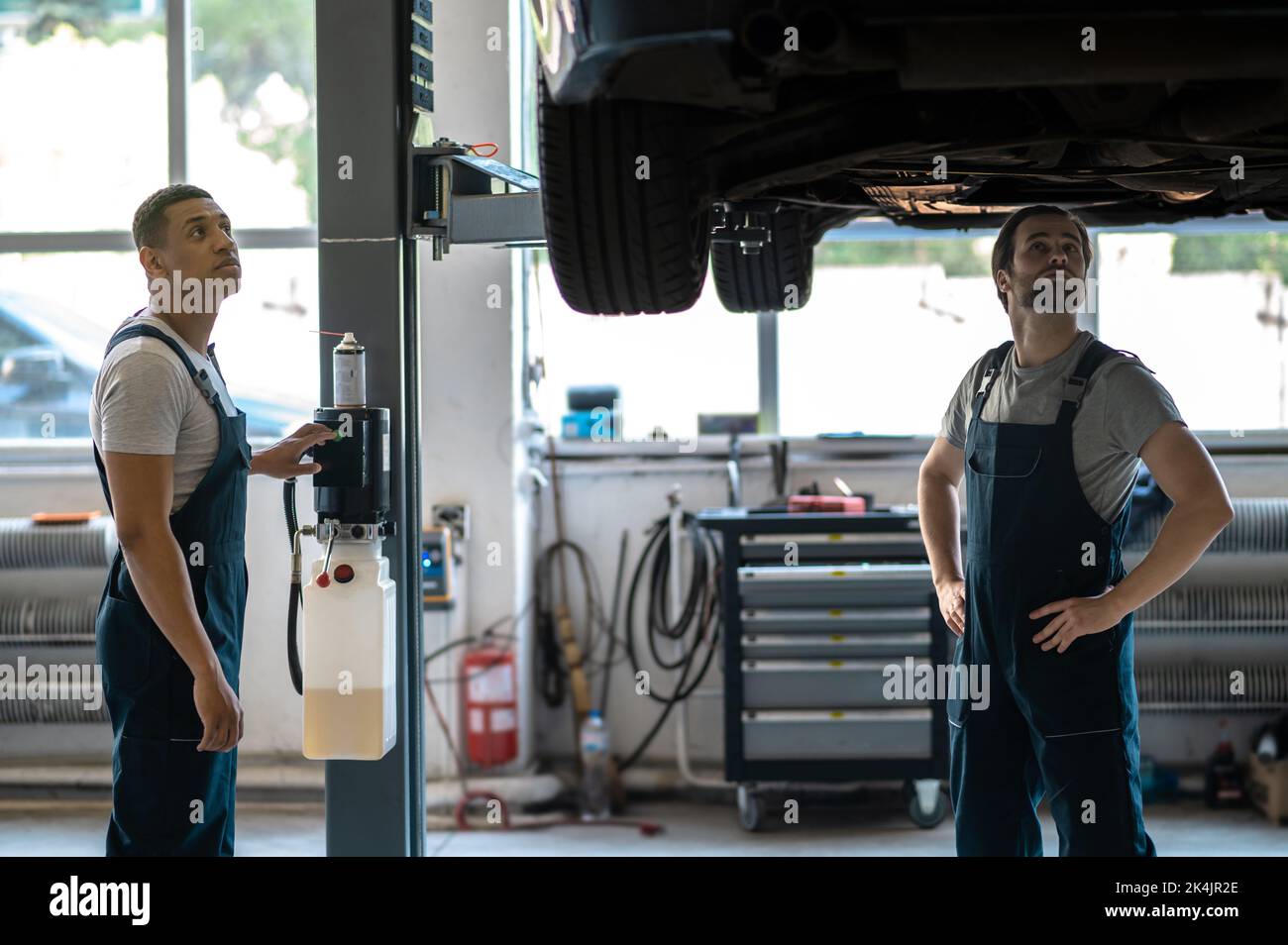 Mechanics preparing the client vehicle for visual inspection Stock ...
