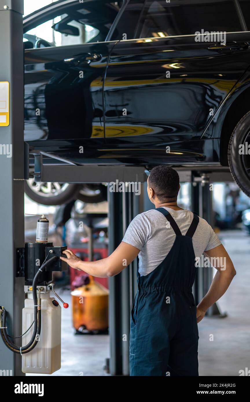 Automotive technician preparing the customer automobile for visual ...