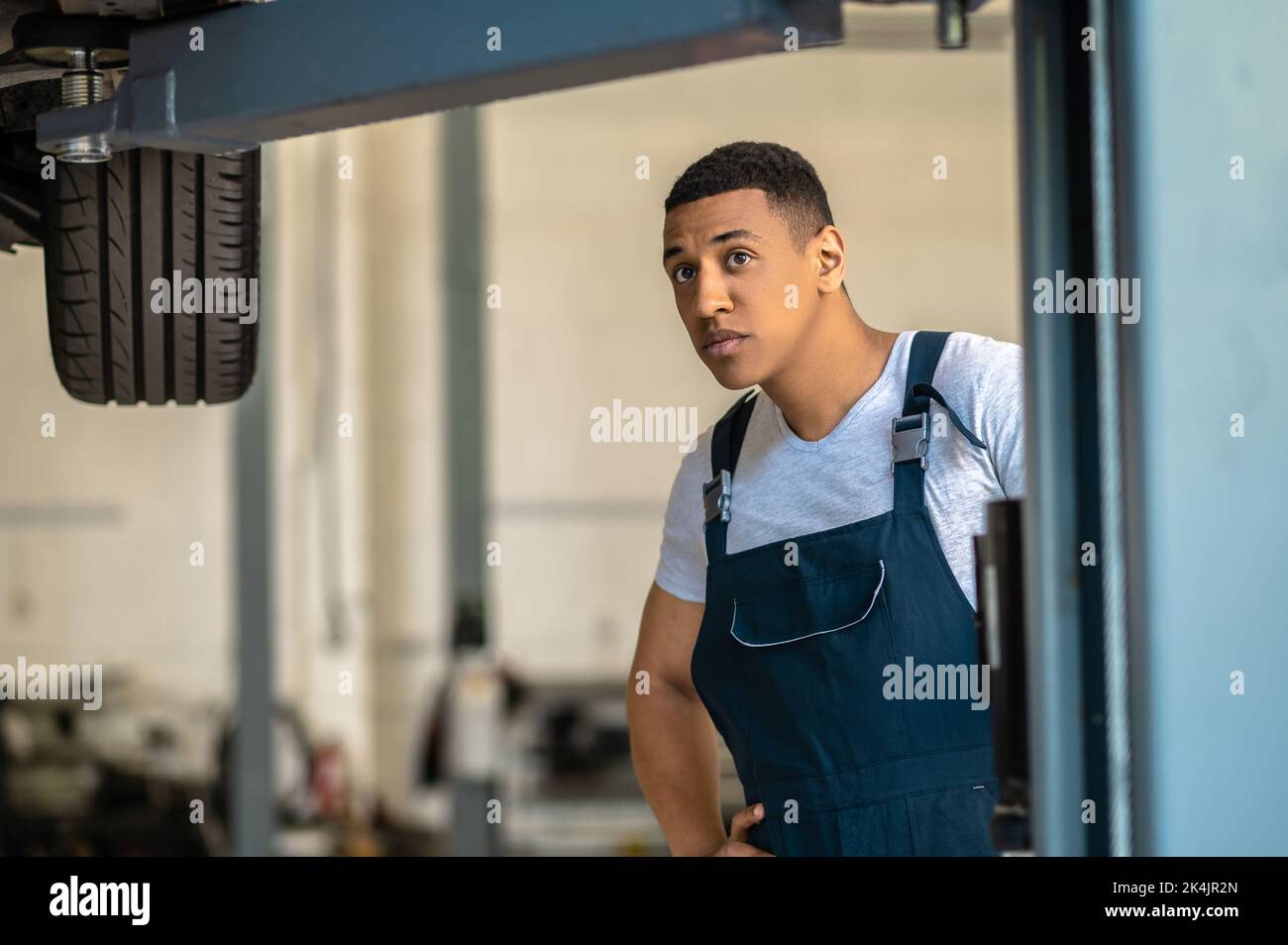 Professional mechanic preparing the client auto for visual inspection ...