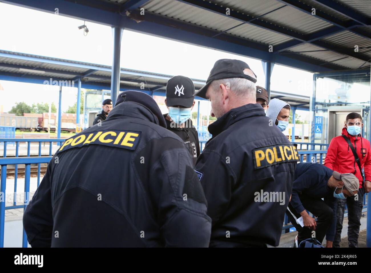 Police officers at the railway station in Breclav inspect a train ...