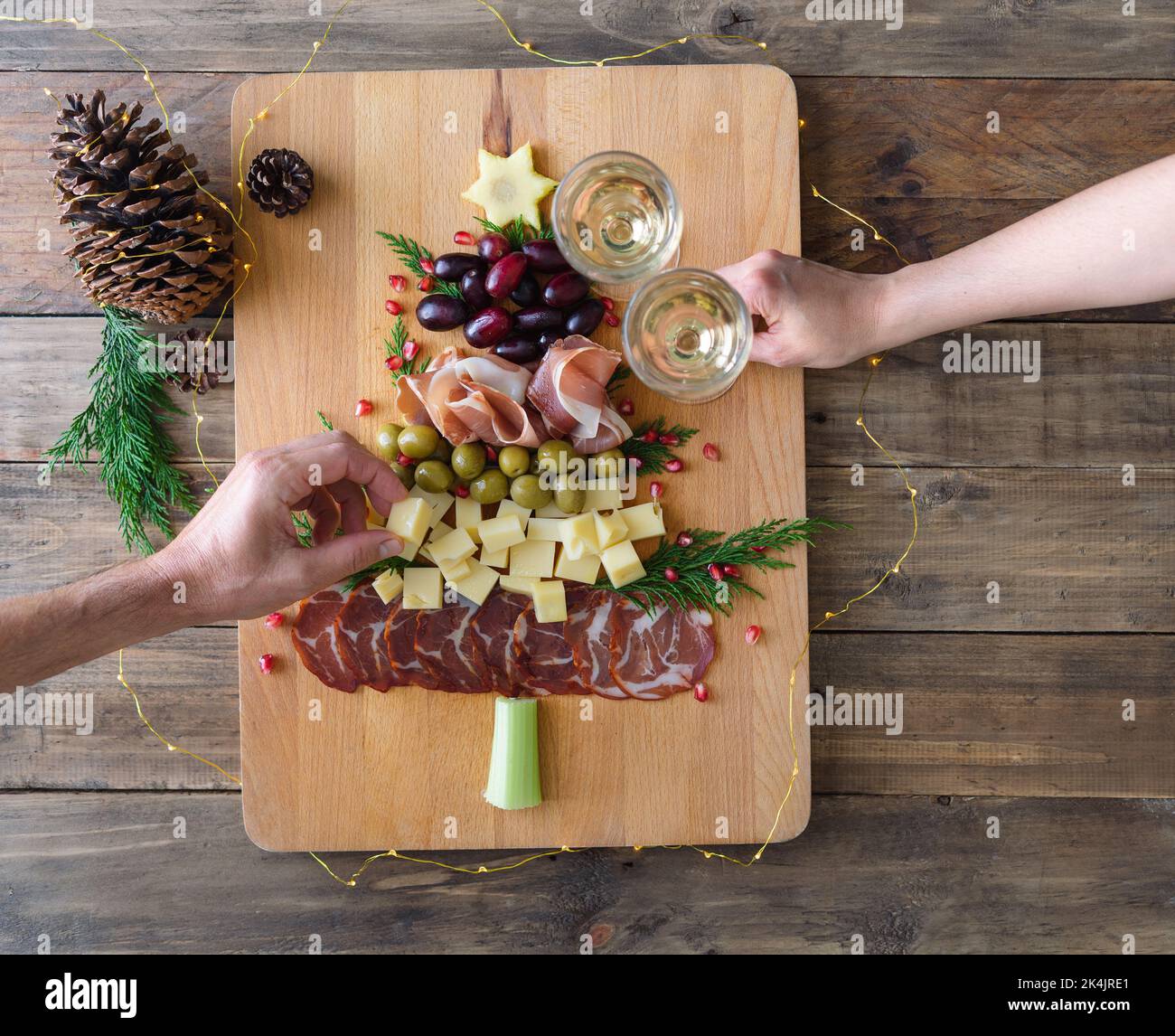 Cheese and charcuterie board in the shape of a Christmas tree. Two ...