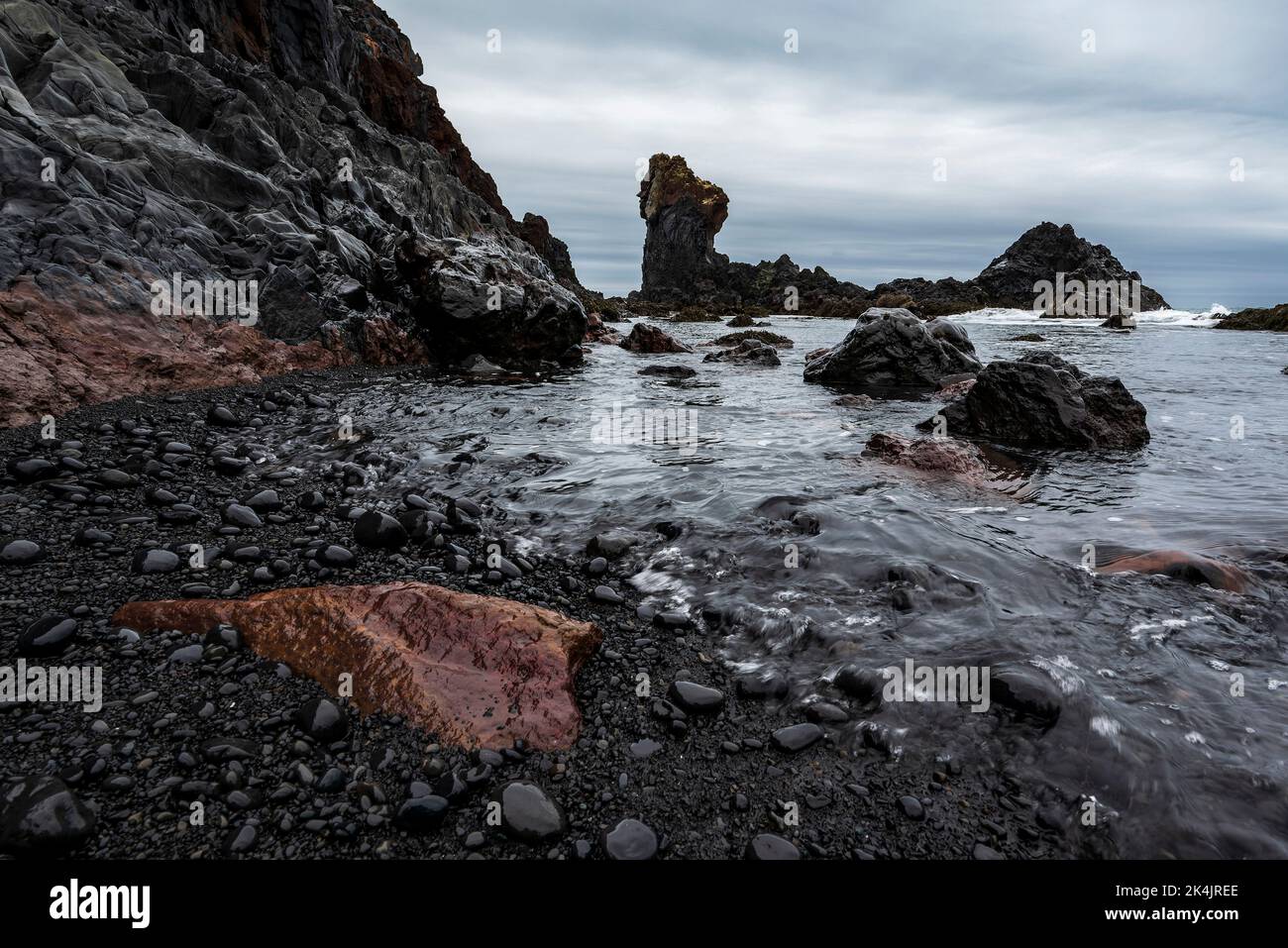 Bizarre black basalt rock formations and volcanic lava boulders in the ...