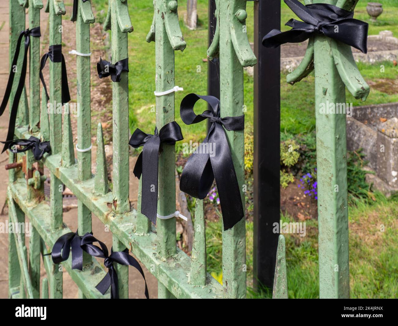 Black ribbons fixed to a church gate to remember the passing of Queen ...