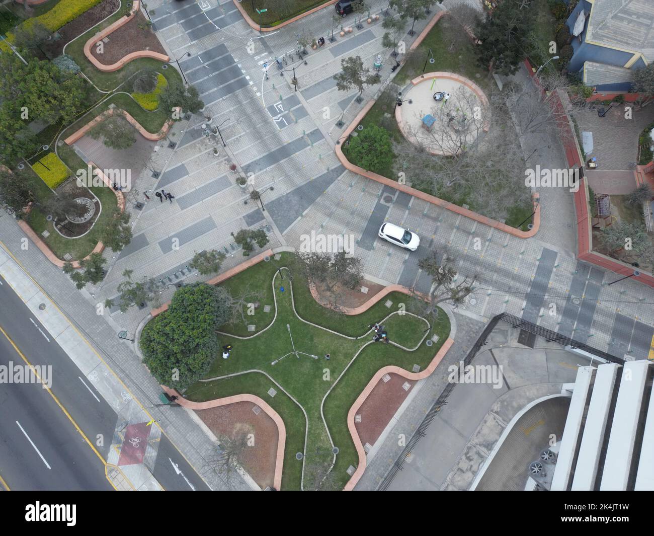An aerial view of a street and small green parks in San Isidro, Lima ...
