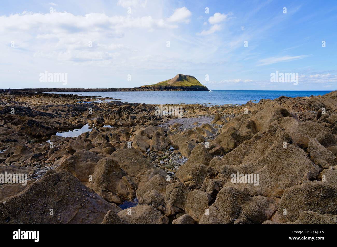 Rugged, curving causeway from Rhossili Point out to the Worms Head at ...