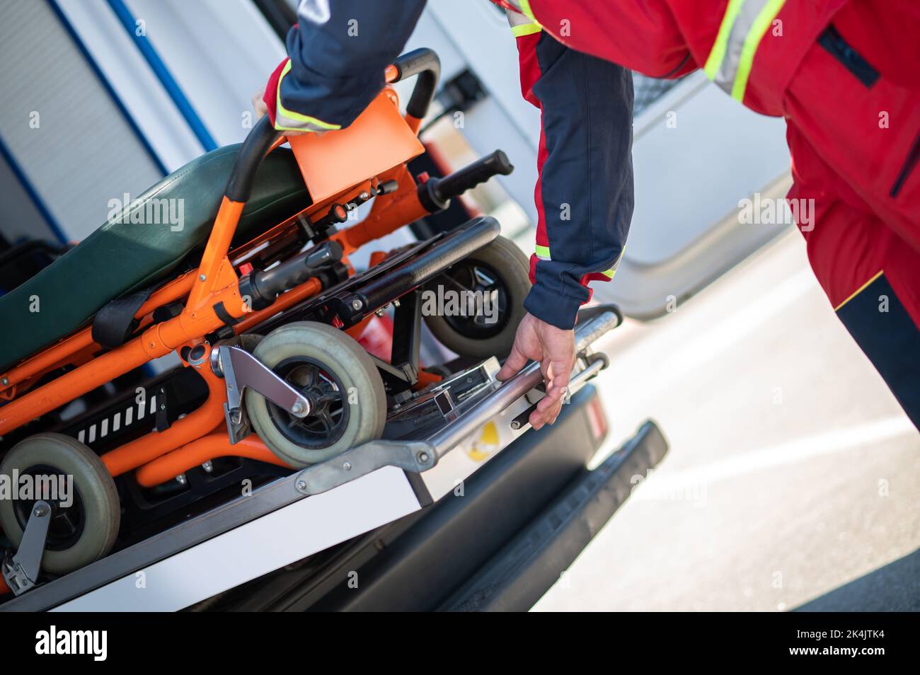 EMT taking out a hospital gurney from the ambulance car Stock Photo - Alamy