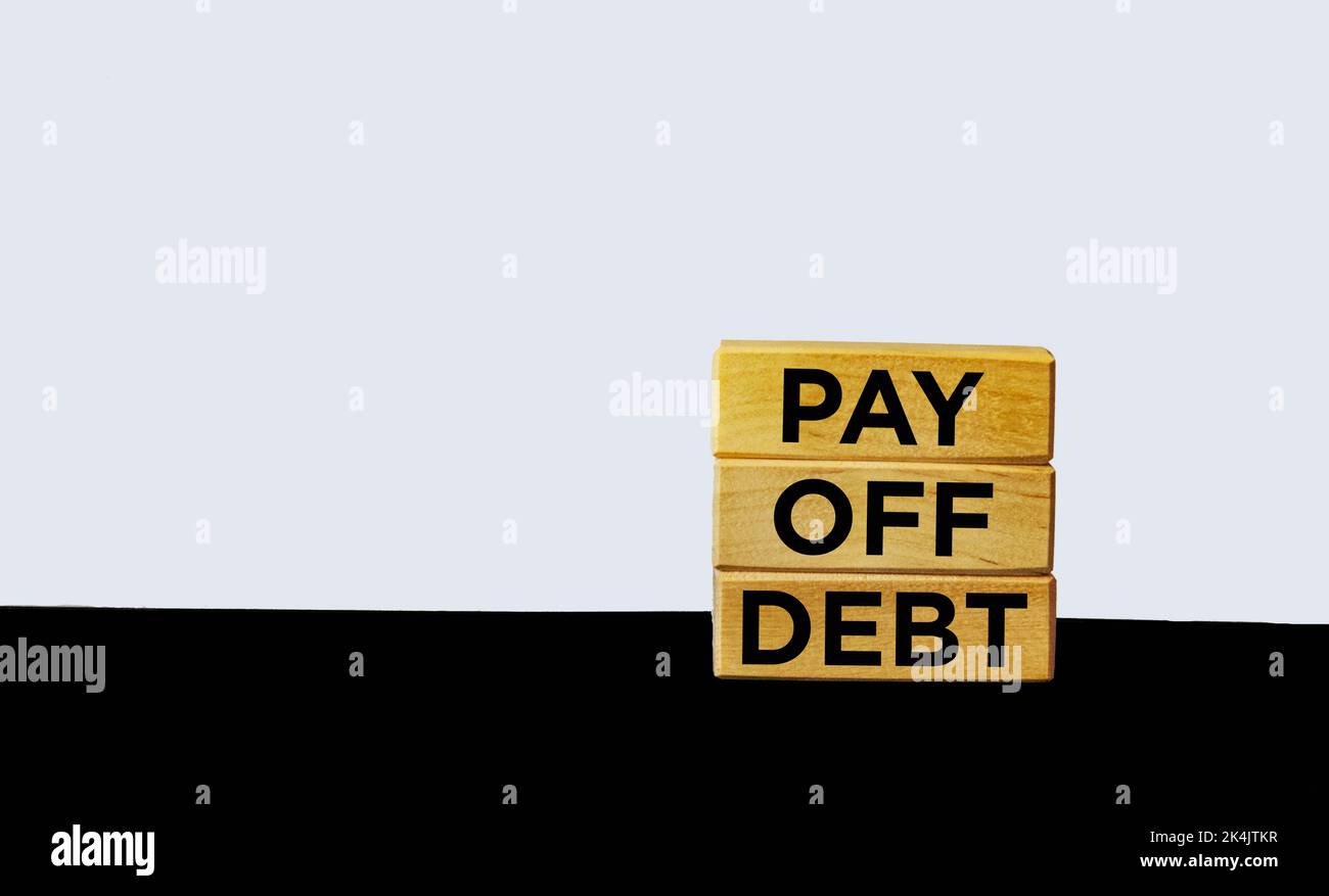 Pay Off Debt text concept written on wooden blocks lying on white and ...