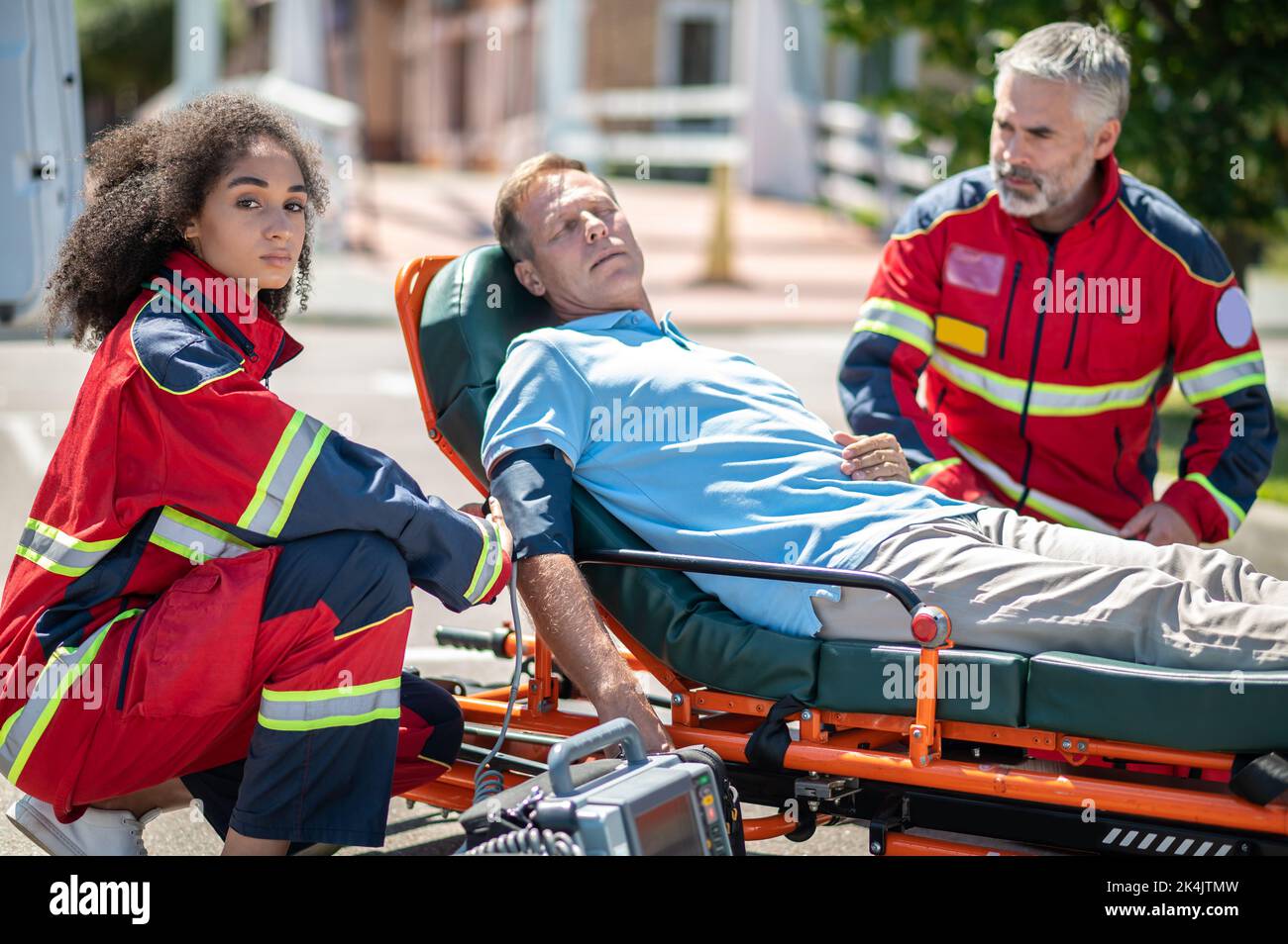 Paramedical staff providing emergency care to a car accident victim ...