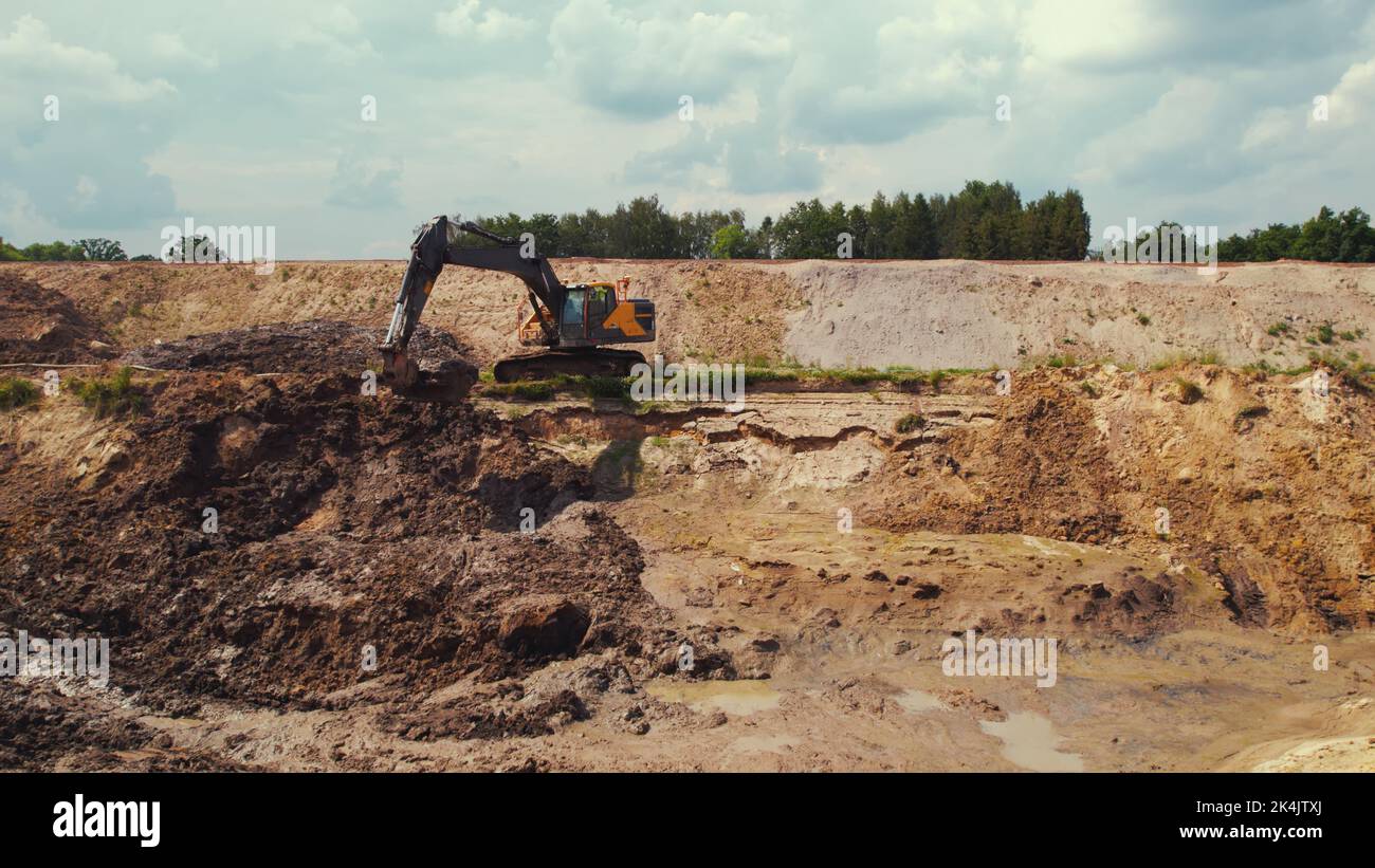 Long-reach crawler excavator during earthmoving works on construction ...