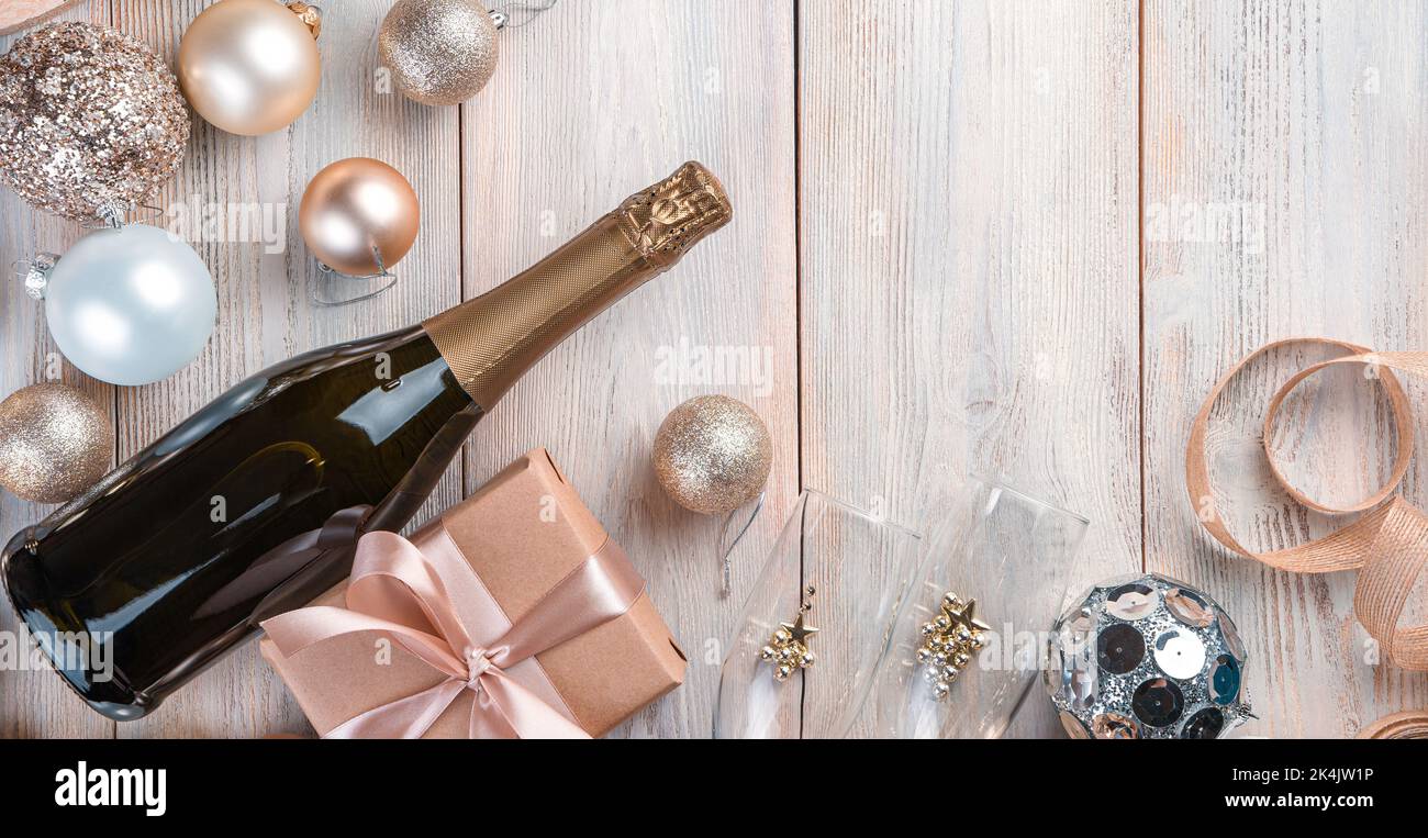Champagne, Christmas balls and gifts on a beige background Stock Photo ...
