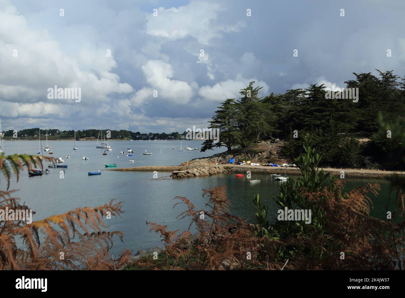 Cloudy sky and view from Sentier Cotier of harbour of Le Goret, Ile Aux ...