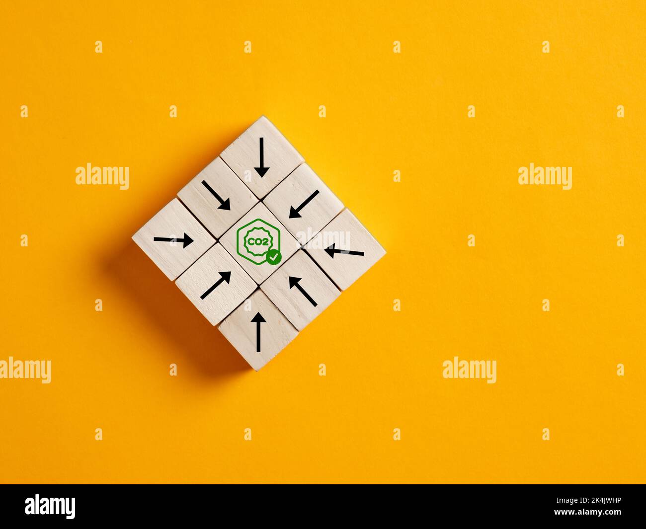 Arrows on wooden cubes pointing towards the carbon credit symbol ...