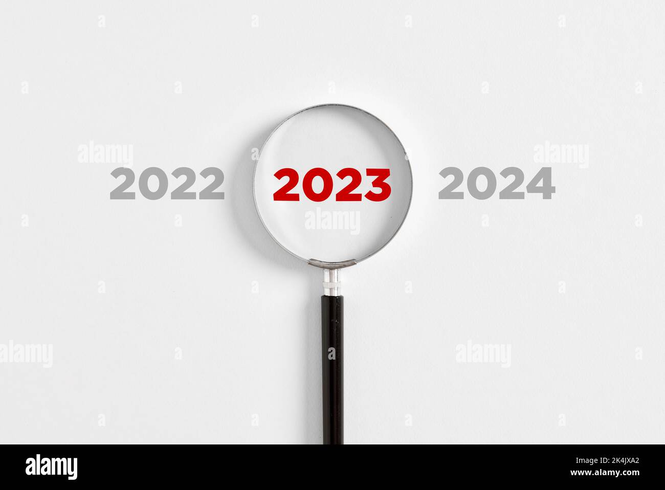 Magnifying glass magnifies the year 2023 between the years 2022 and ...
