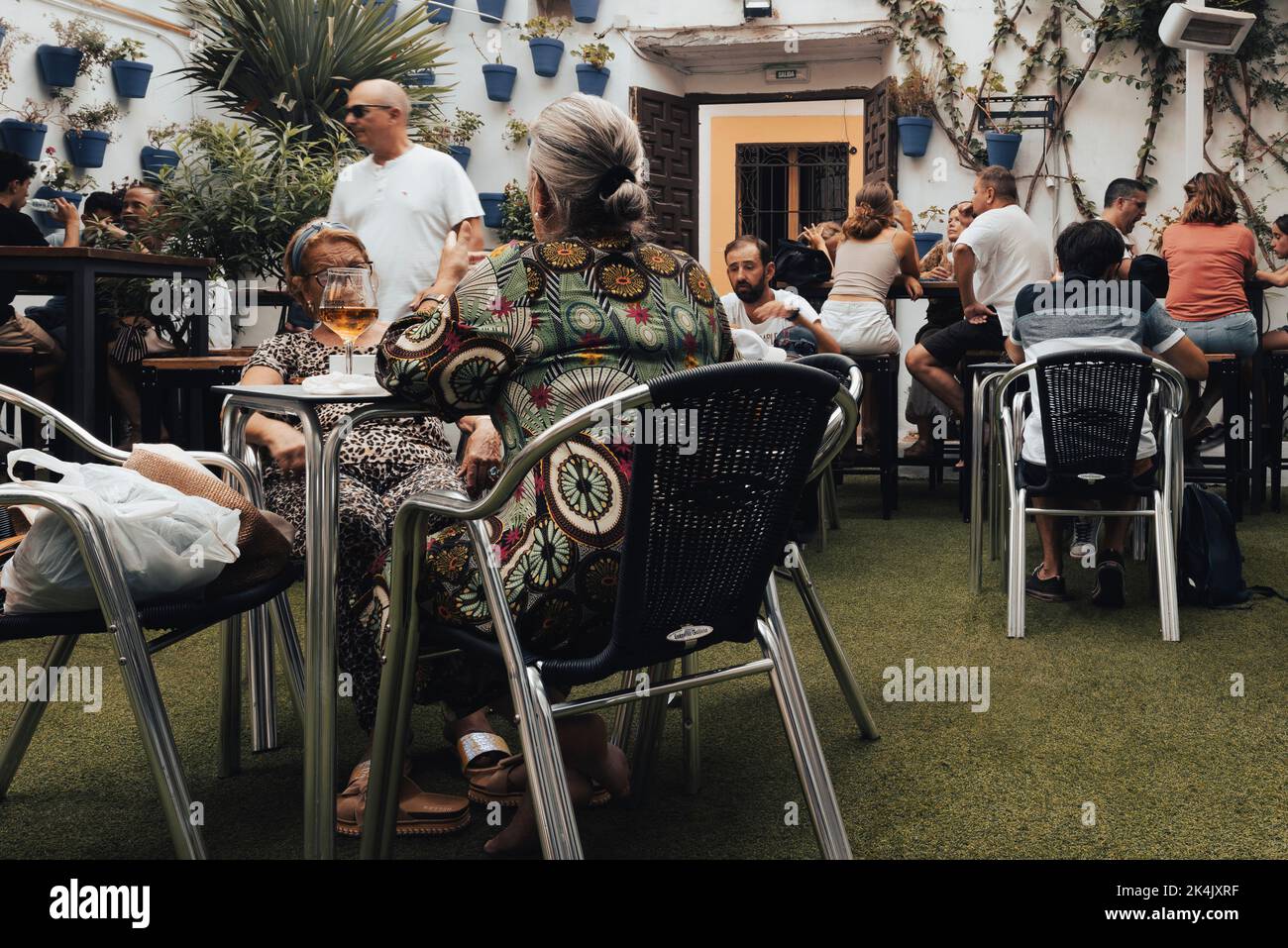 People having an aperitif on a typical Andalusian patio. Cordoba ...