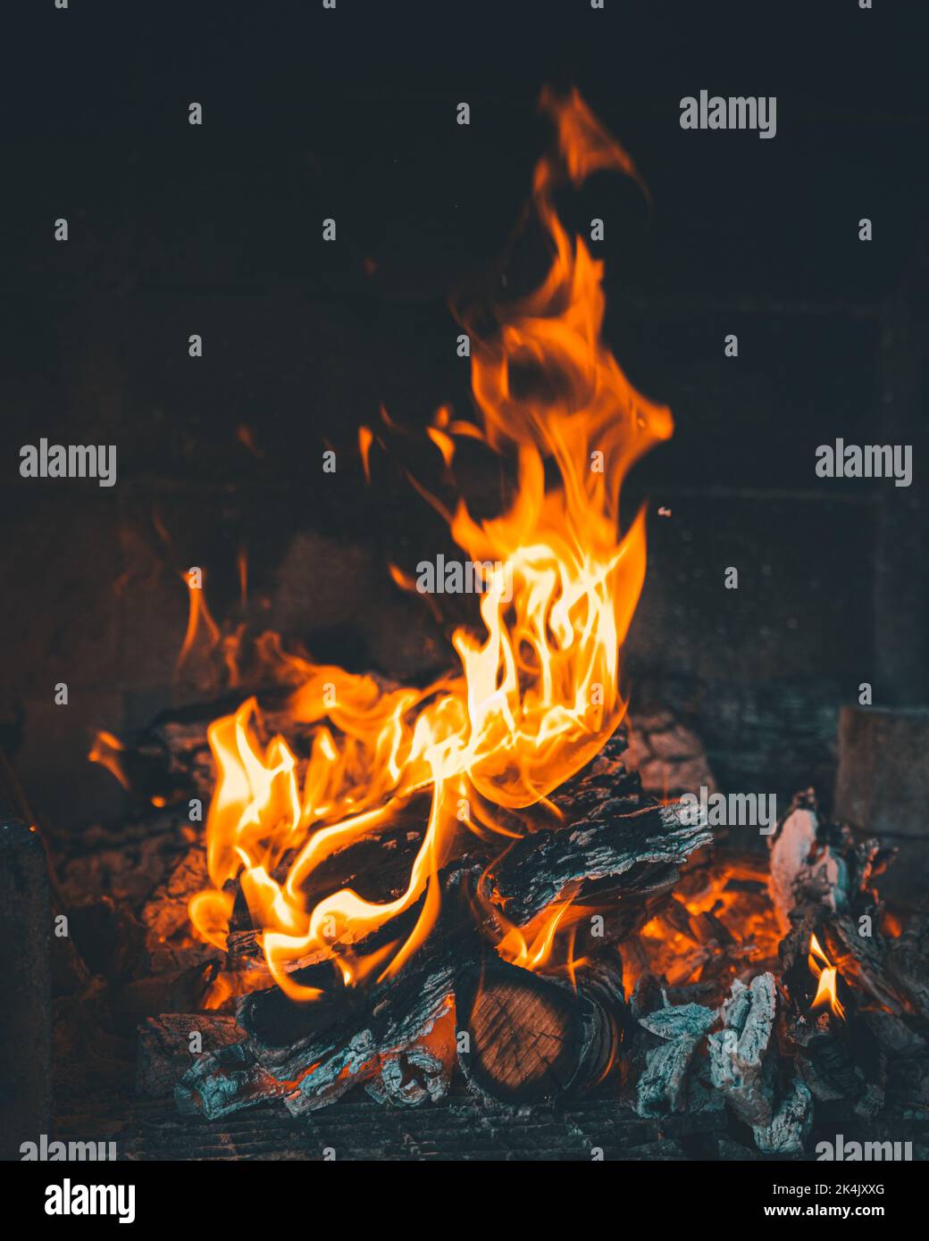 A vertical of a burning fire flames captured in a fireplace Stock Photo ...