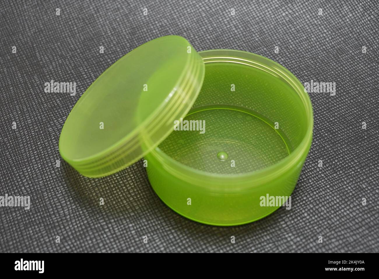 Plastic caps. Close up, One green plastic bowl on white background ...