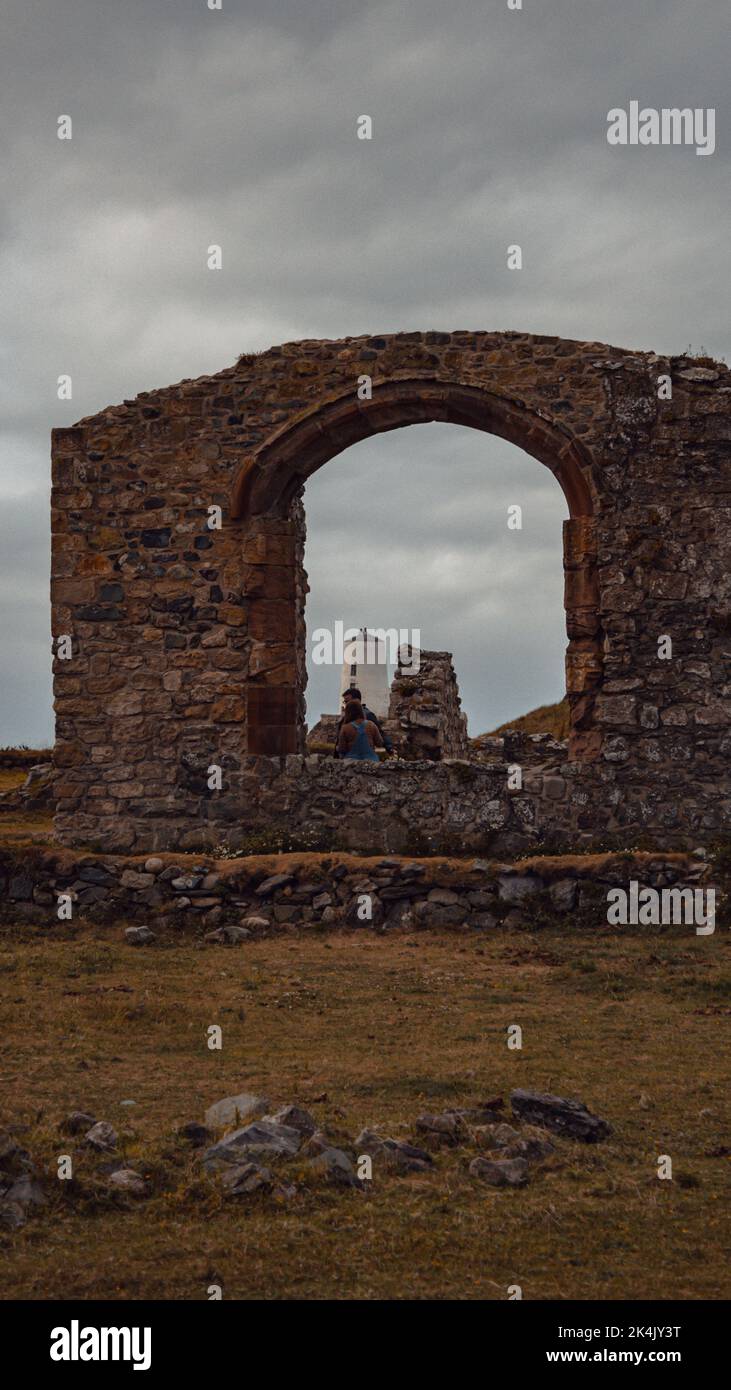A vertical shot of ruins of an ancient arch, the home of the patron ...