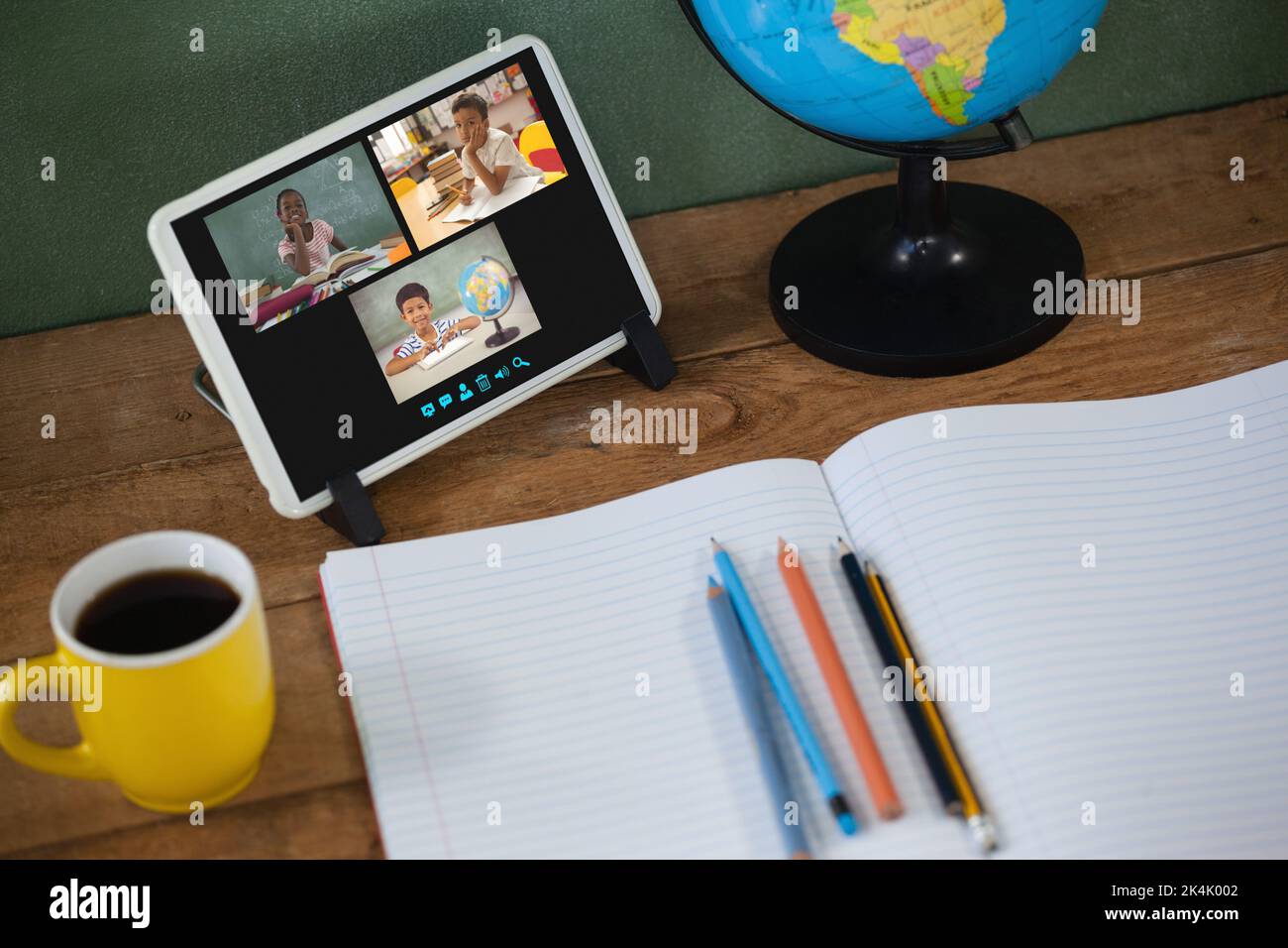 Smiling diverse elementary school pupils during class on tablet screen ...