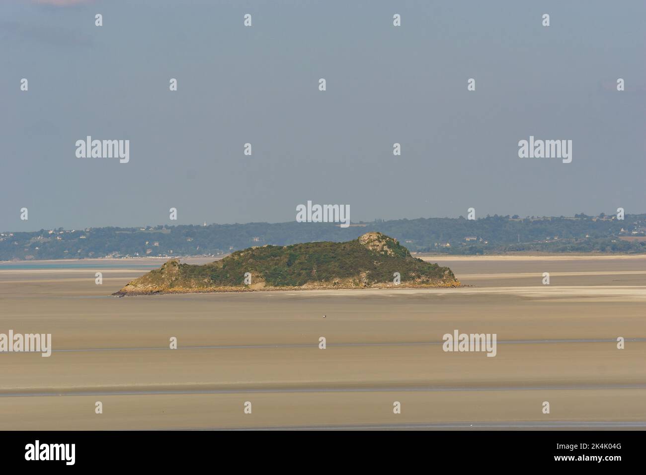 Island surrounded by sand during low tide near Mont Saint Michel ...
