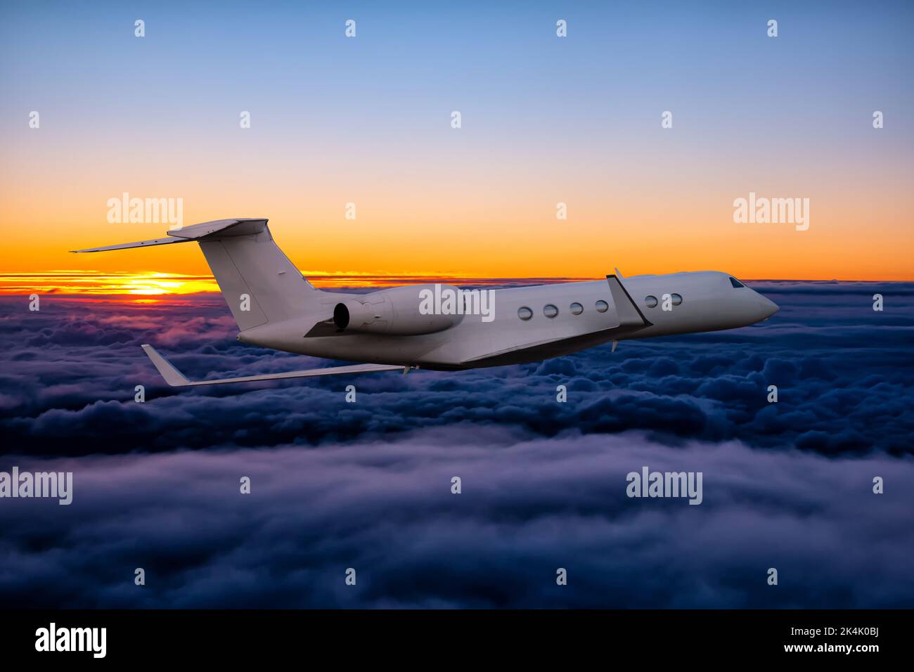 White modern private jet flies in the sunset sky Stock Photo - Alamy