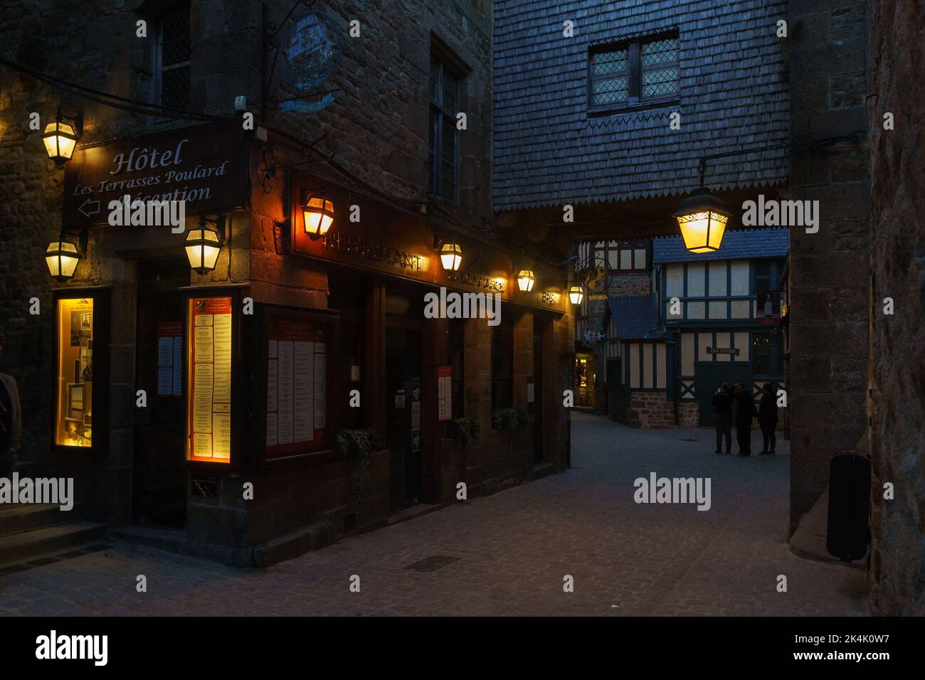 Typical street at night with lamps at Le Mont Saint Michel, Normandy ...