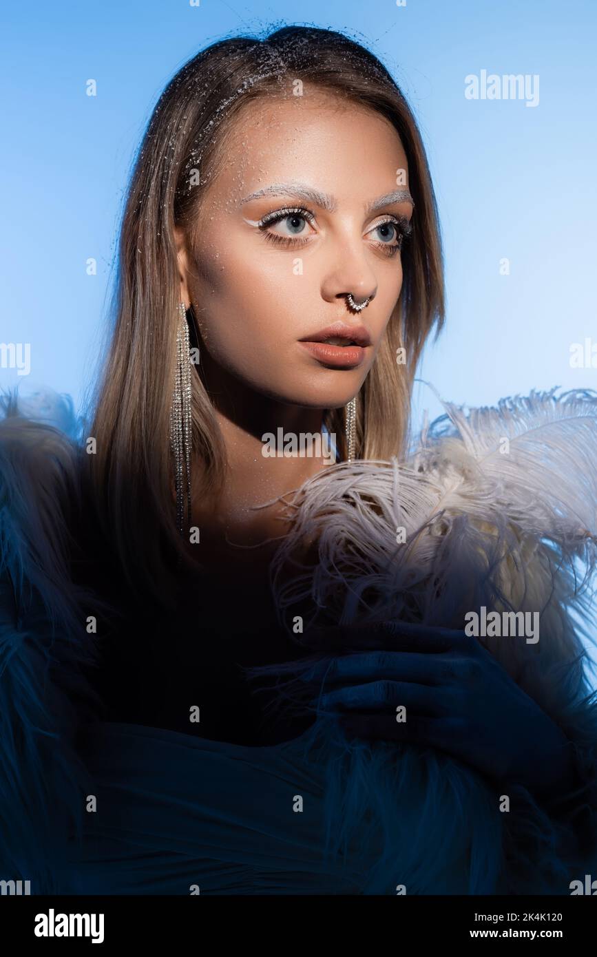 young blonde woman with snowy eyebrows and piercing looking away on ...