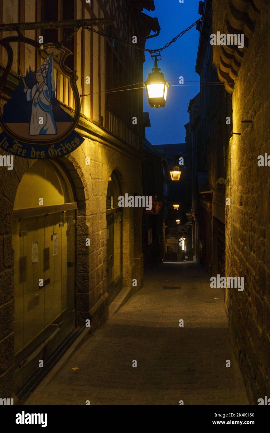 Typical street at night with lamps at Le Mont Saint Michel, Normandy ...