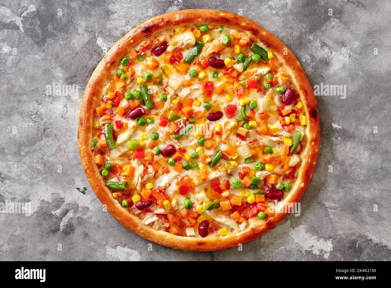 Colorful pizza with mozzarella, sous vide chicken, vegetable mix on ...