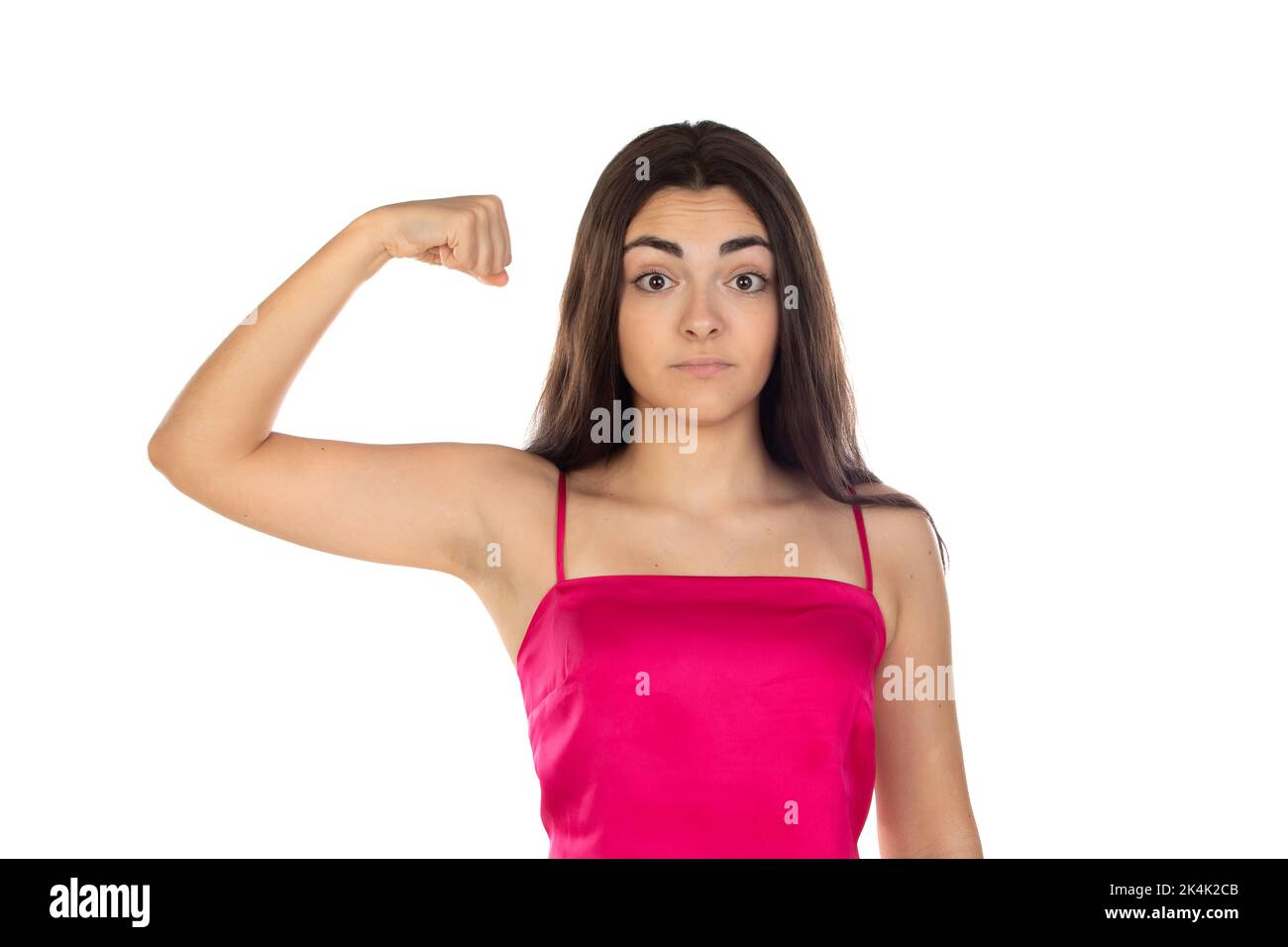 Strong powerful brunette woman with raises arms and shows biceps, wears ...