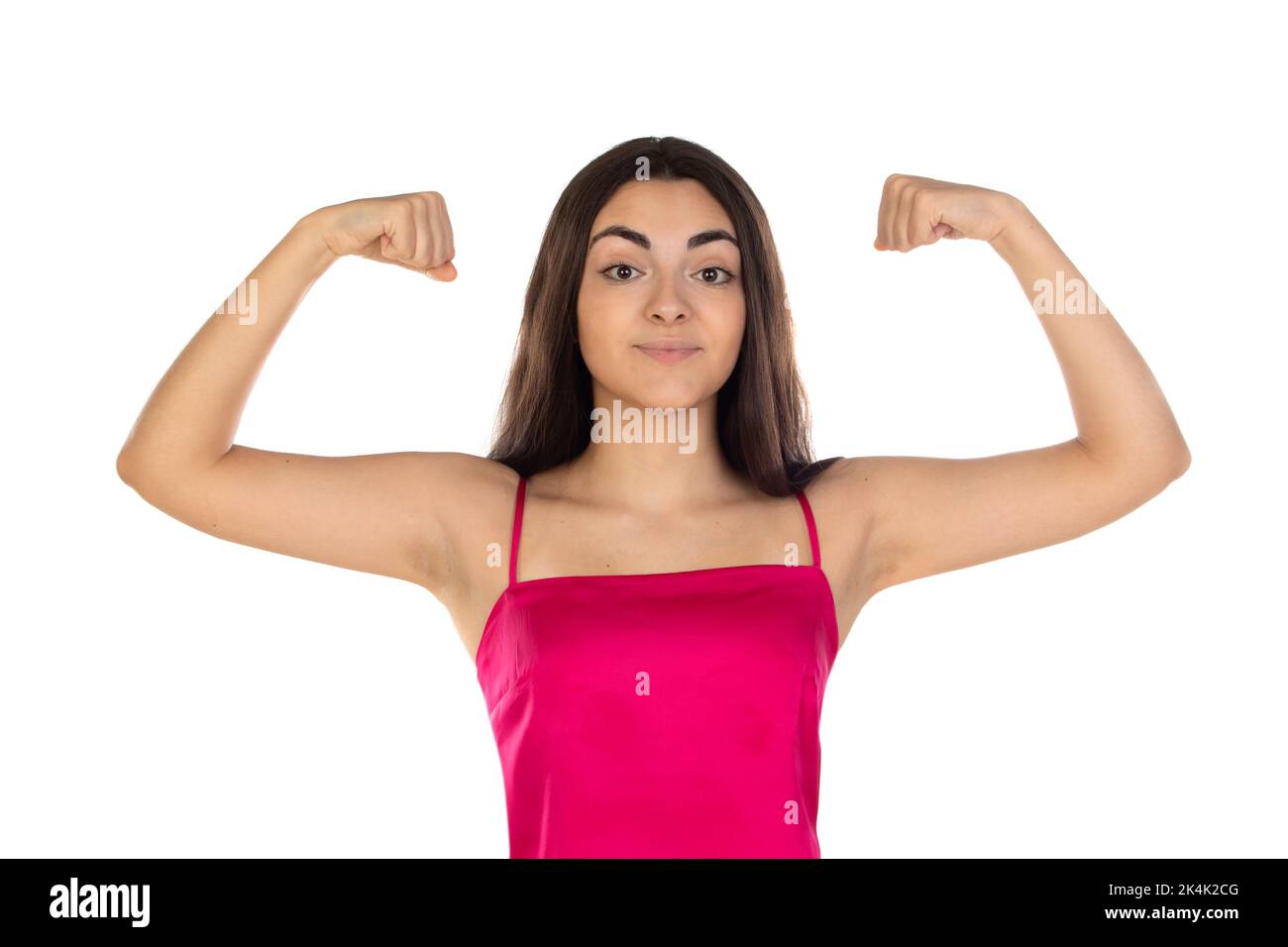 Strong powerful brunette woman with raises arms and shows biceps, wears ...