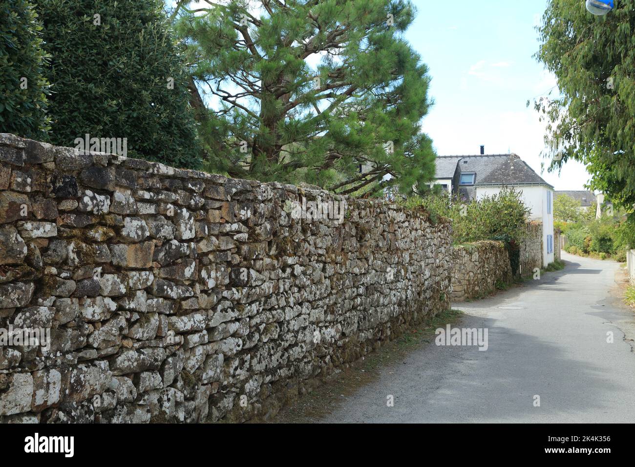 View along dry stone wall and down road, Le Trech, Ile Aux Moines ...
