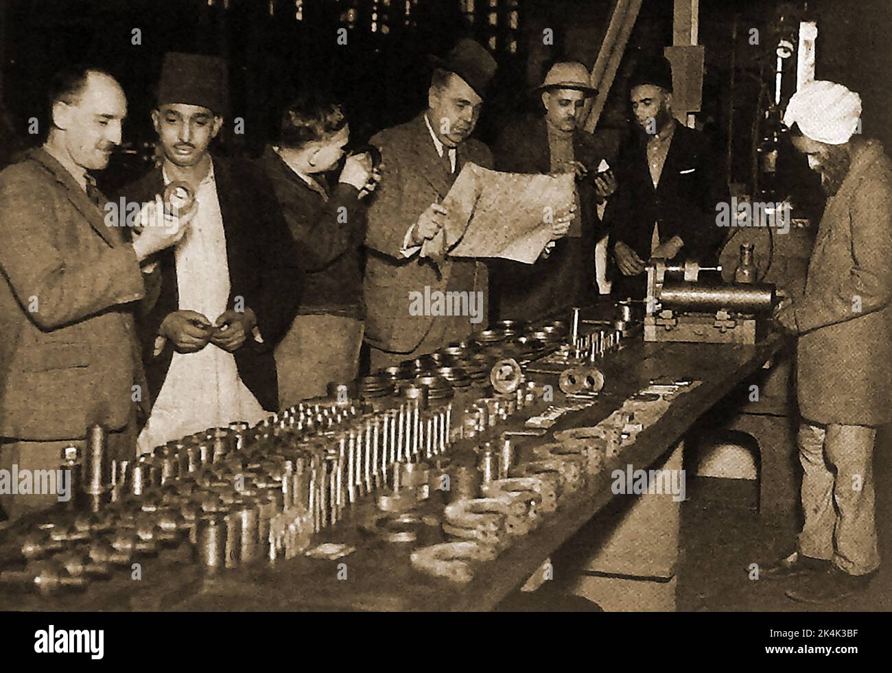 Weapons inspection in the 1940's in an Indian railway workshop that had ...