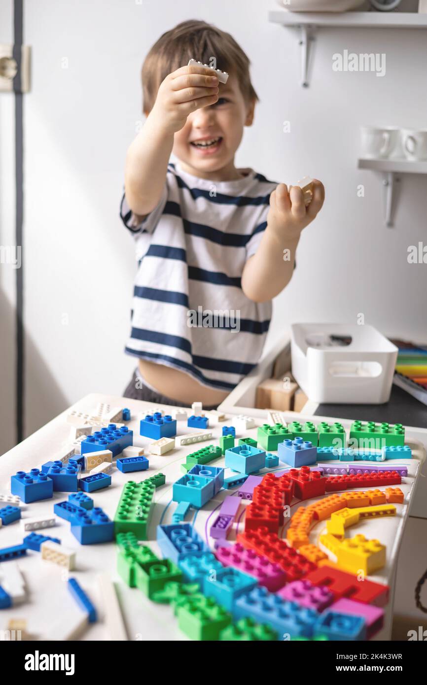 Khabarovsk, Russia, May 11, 2022. Smiling baby boy playing Lego ...