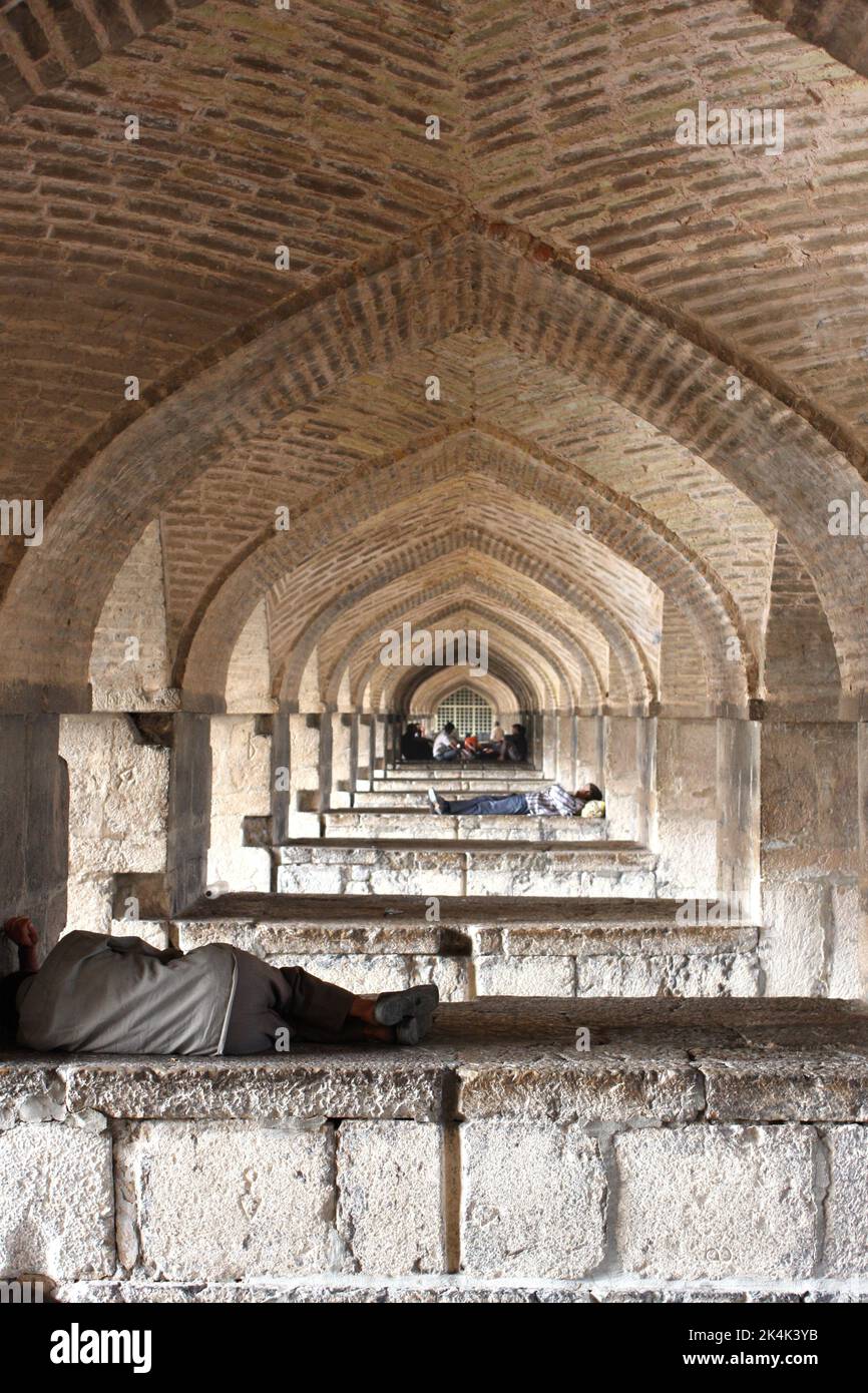Sleeping under the arches of the Si-oh-Seh Bridge, Isfahan, Islamic ...