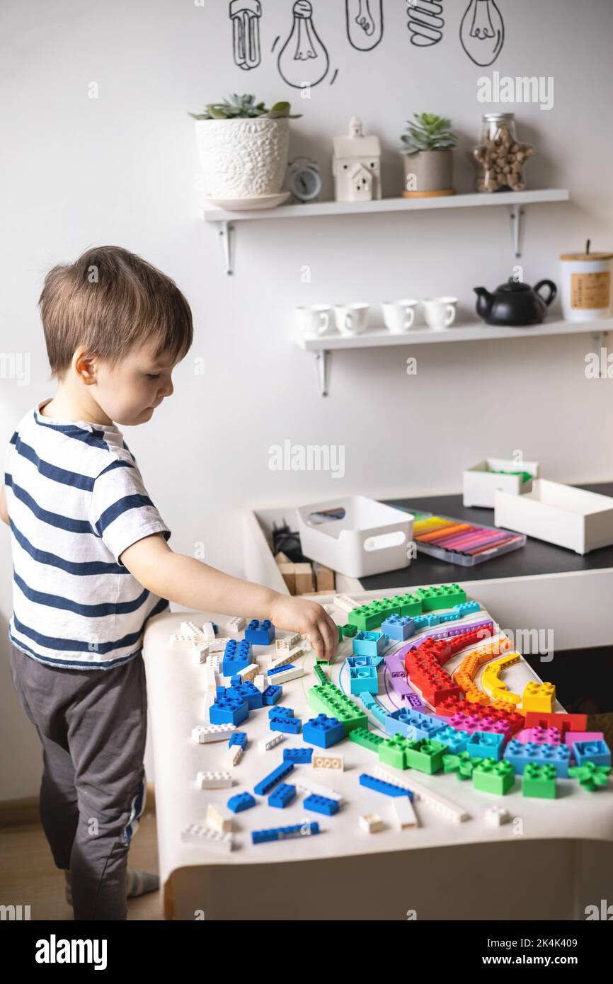 Khabarovsk, Russia, May 11, 2022. Smiling baby boy playing Lego ...