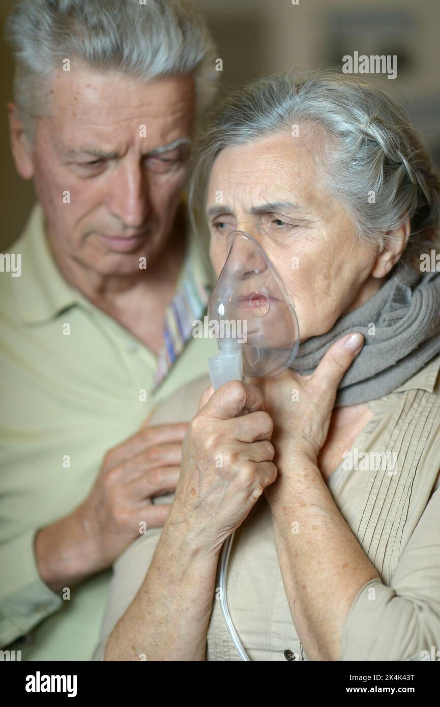 Senior woman using a nebulizer makes inhalation Stock Photo - Alamy