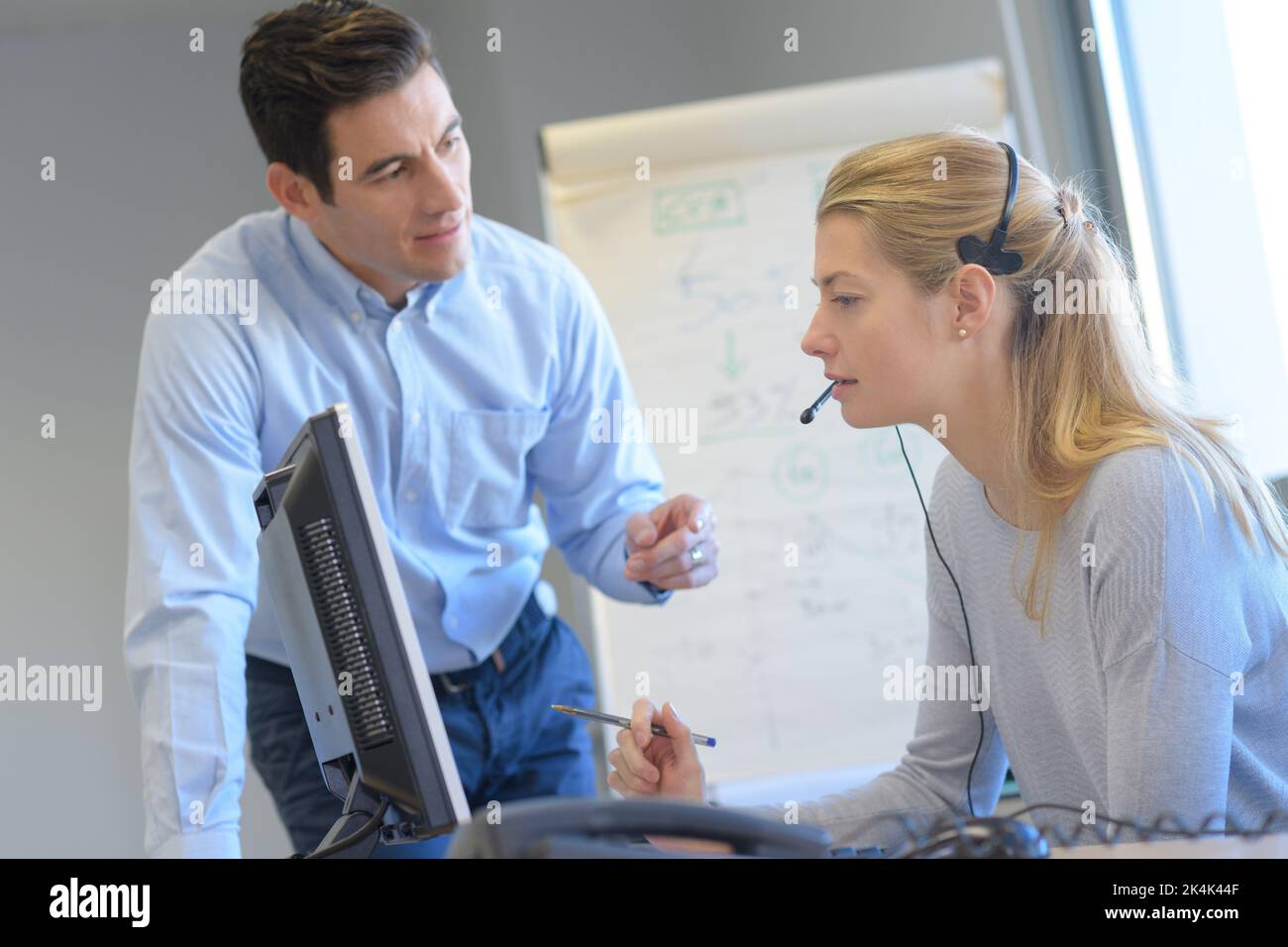 boss bringing additional work to his secretary Stock Photo - Alamy